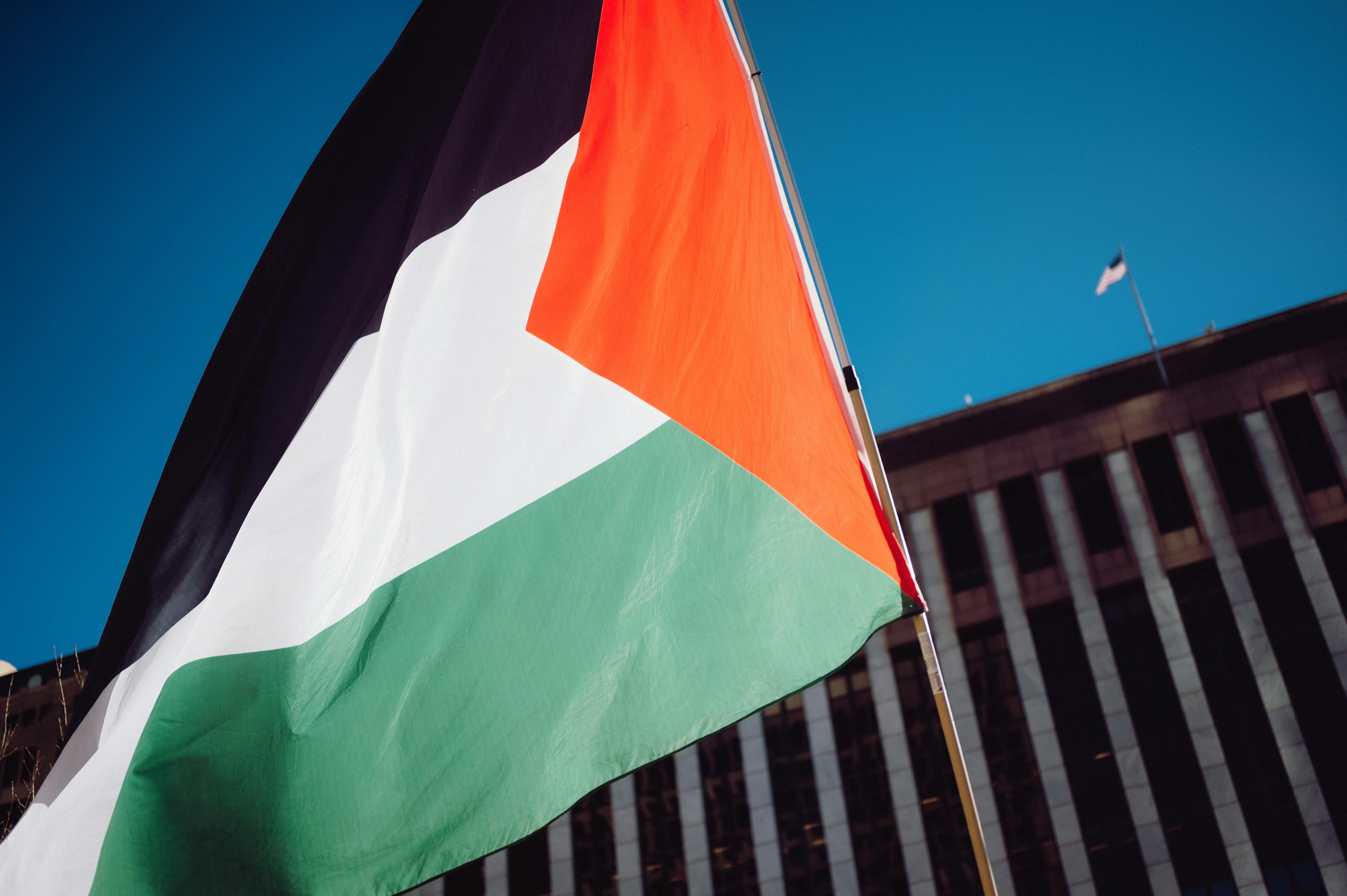 Palestinian Flag Flying against Blue Sky · Free Stock Photo