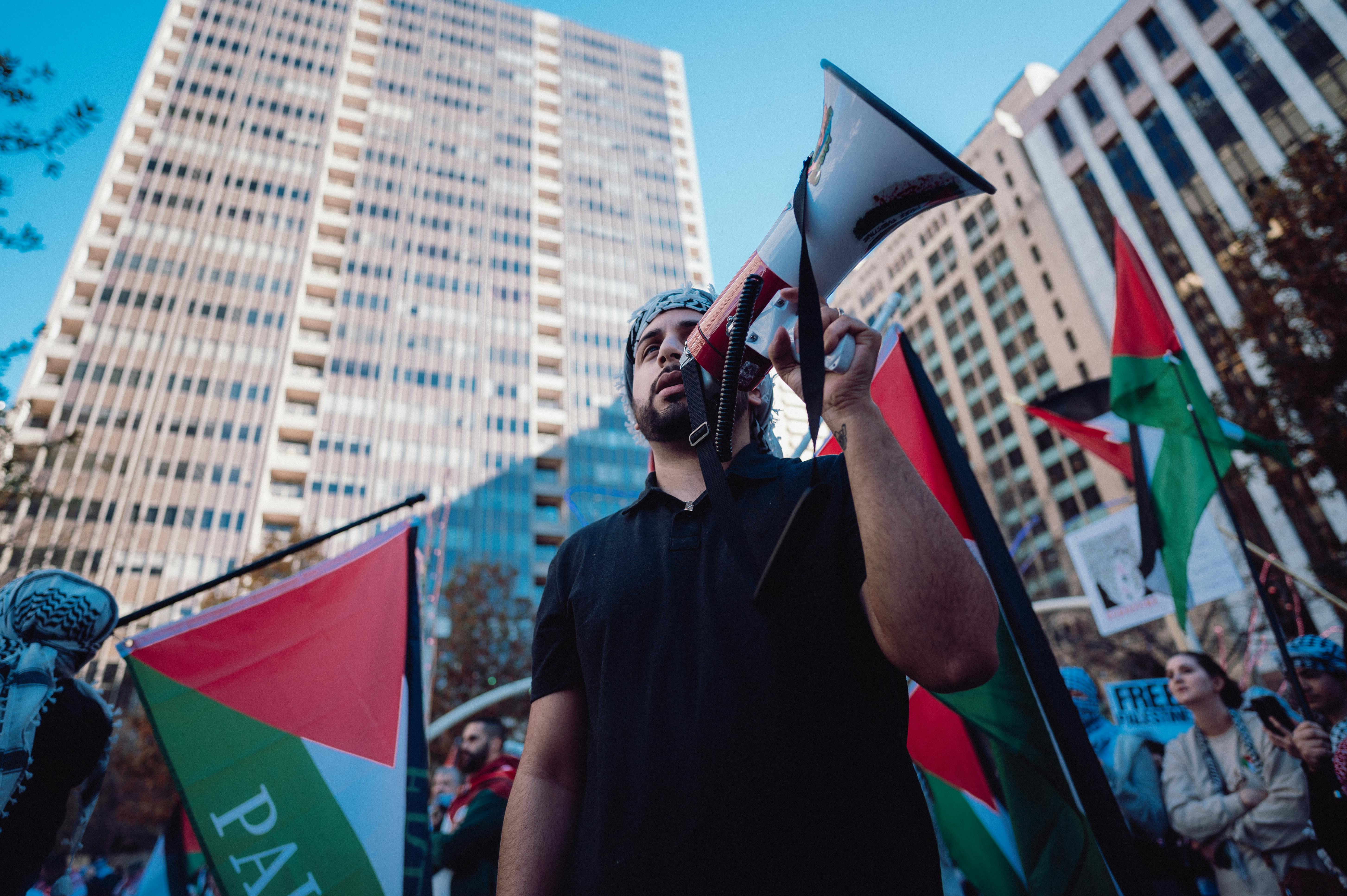 Man with Megaphone Speaking at Rally · Free Stock Photo