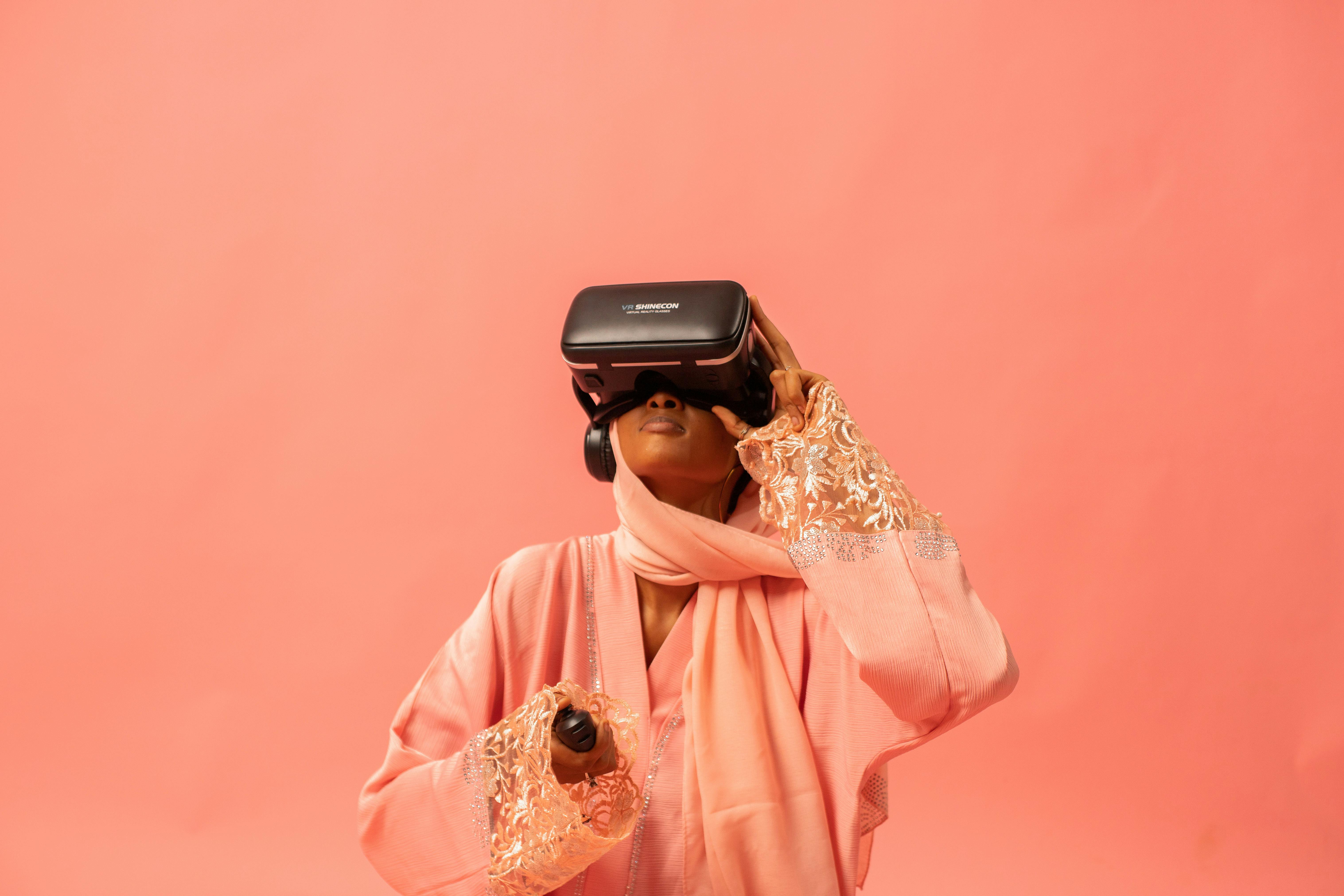 Model in a VR Headset with a Wireless Controller · Free Stock Photo