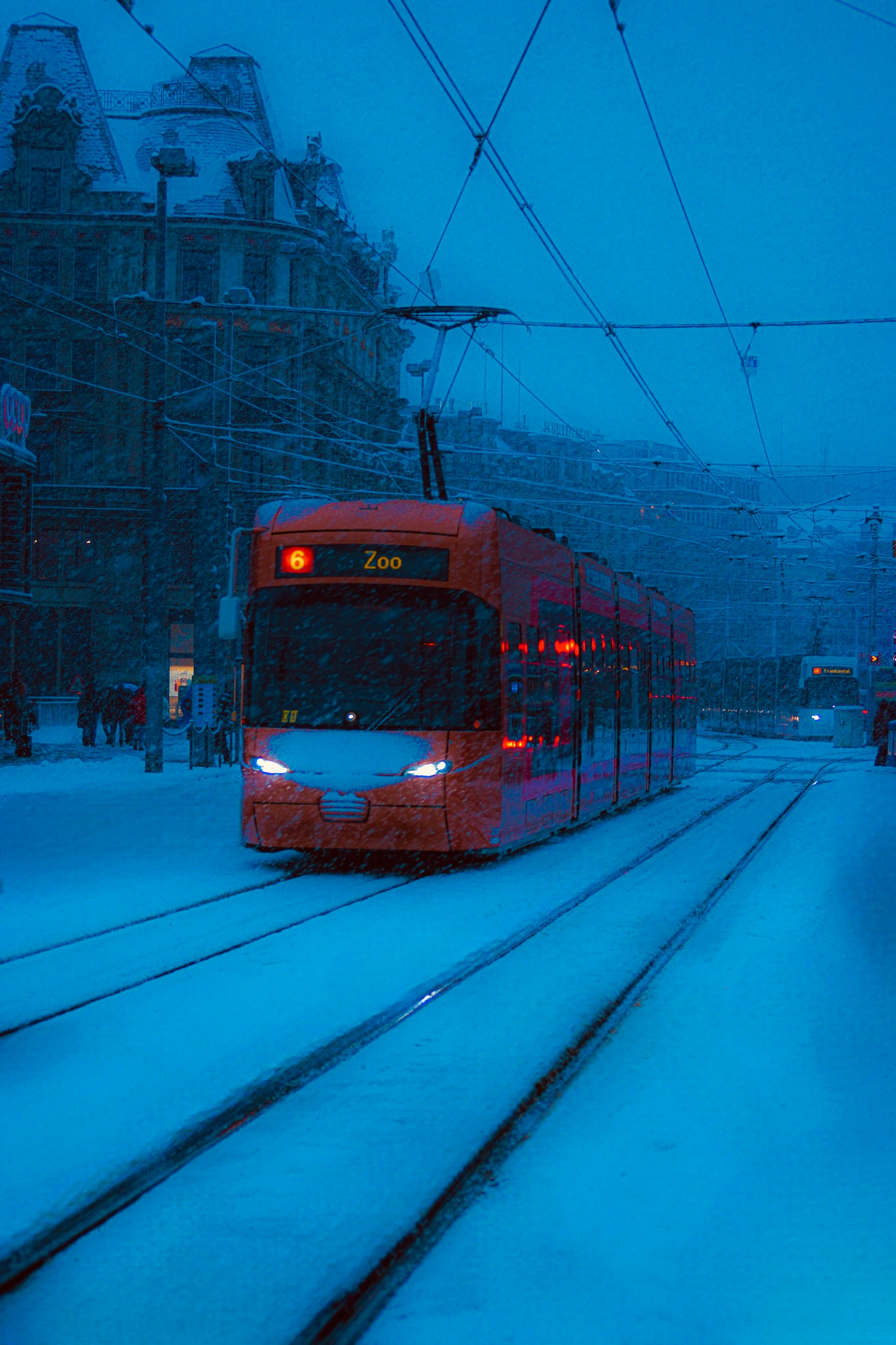 a red tram under heavy snow in zurich city · Free Stock Photo