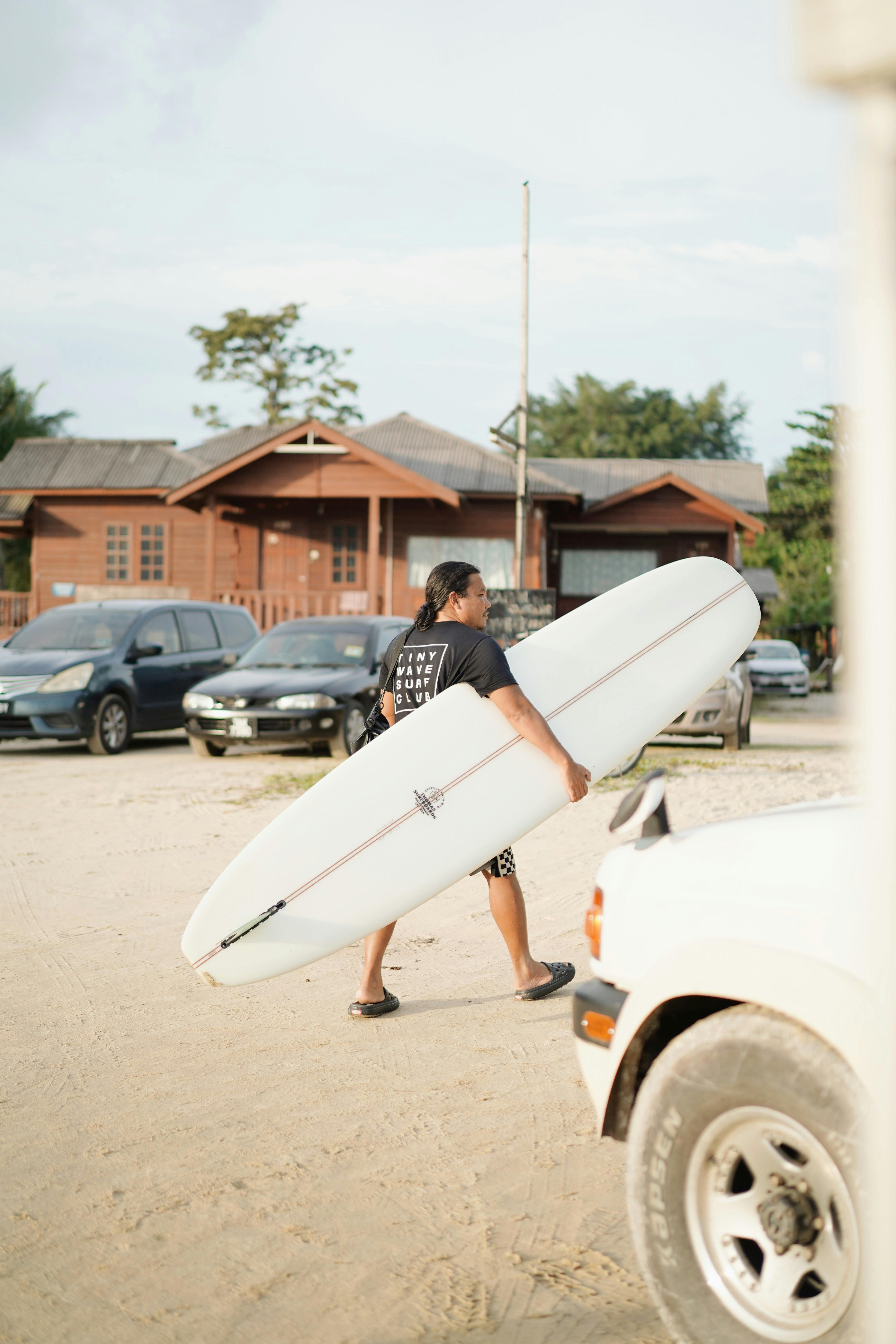 Man Carrying Surfboard · Free Stock Photo
