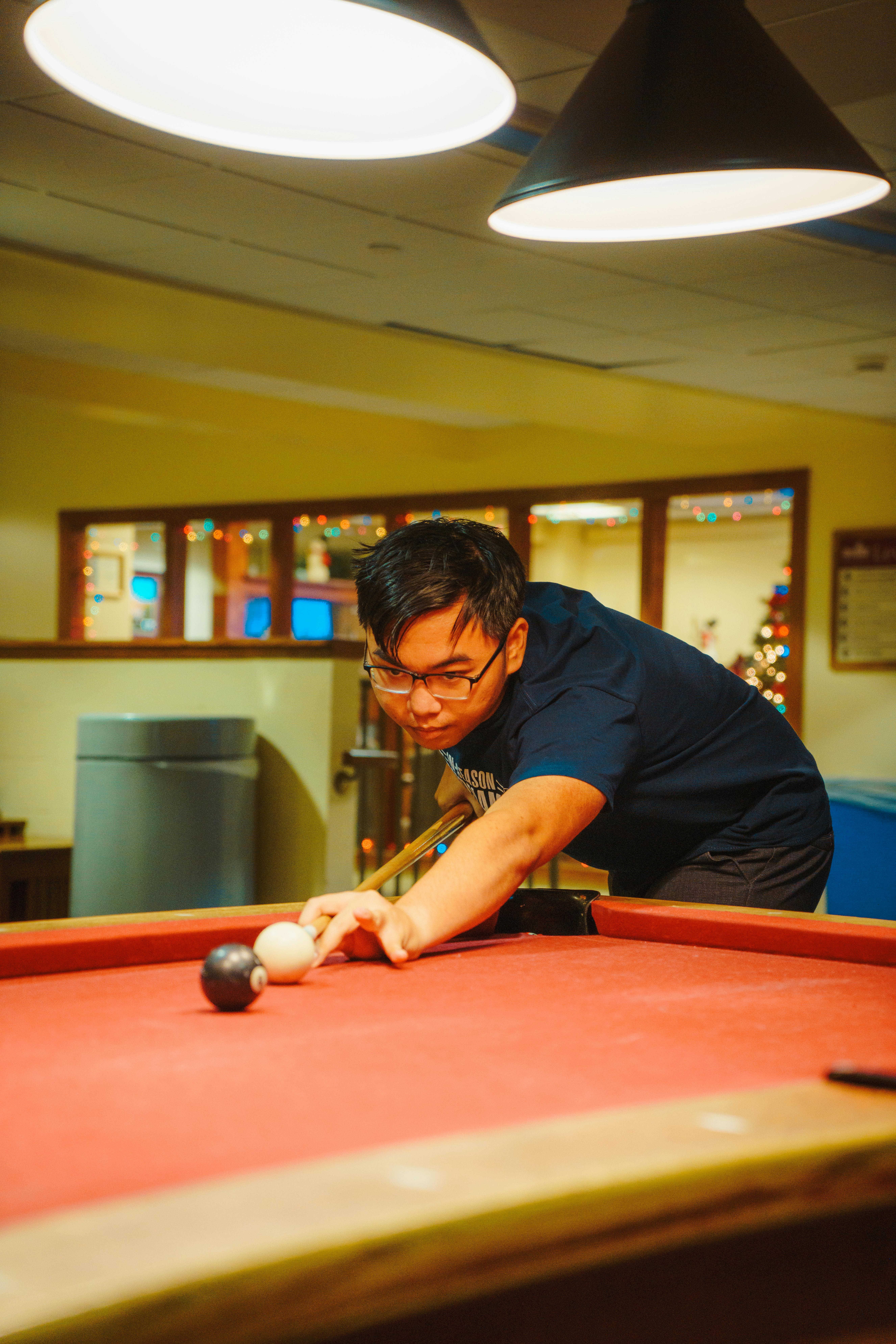 Man Playing Billiards in a Bar · Free Stock Photo
