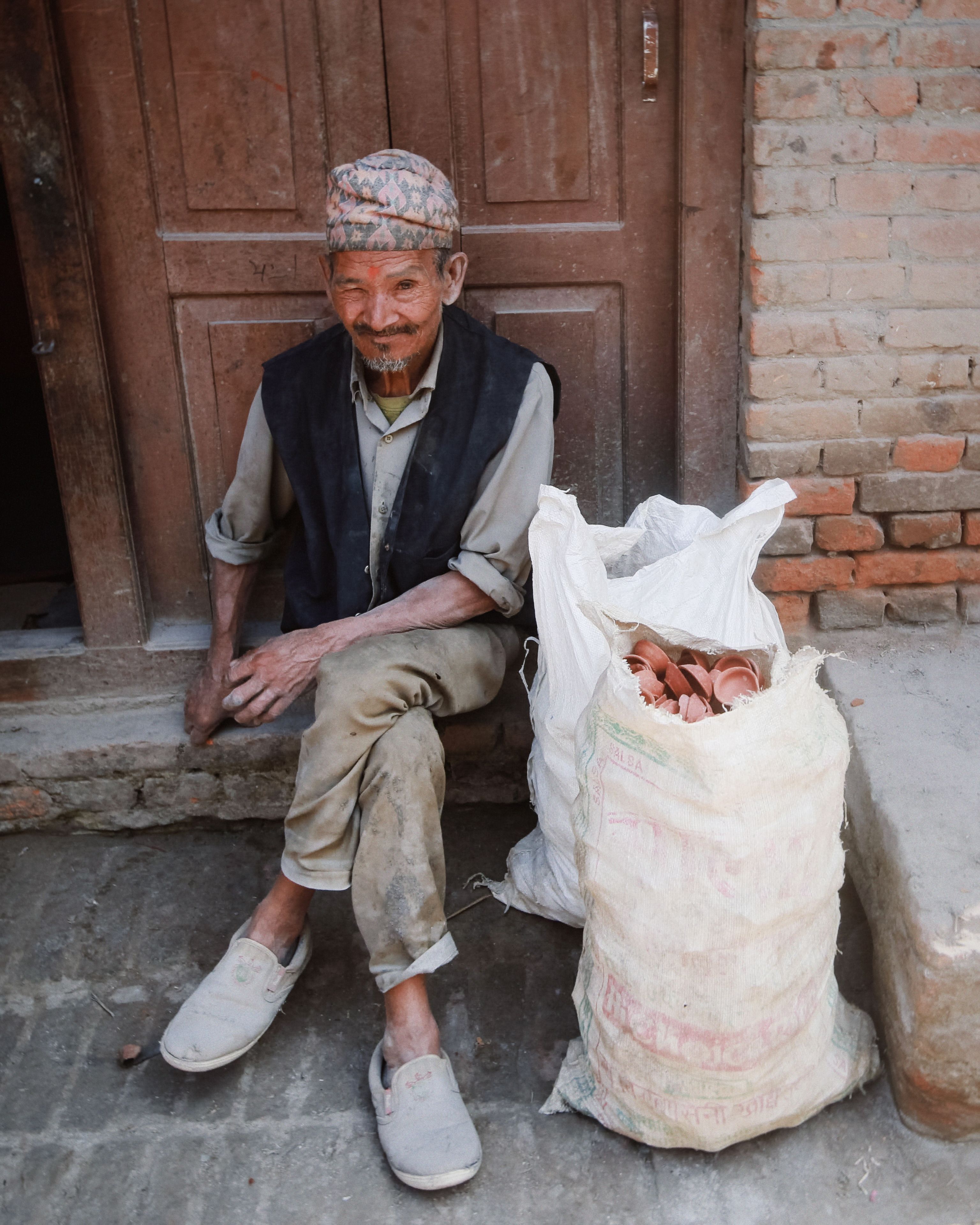An Elderly Man Sitting on the Doorstep · Free Stock Photo