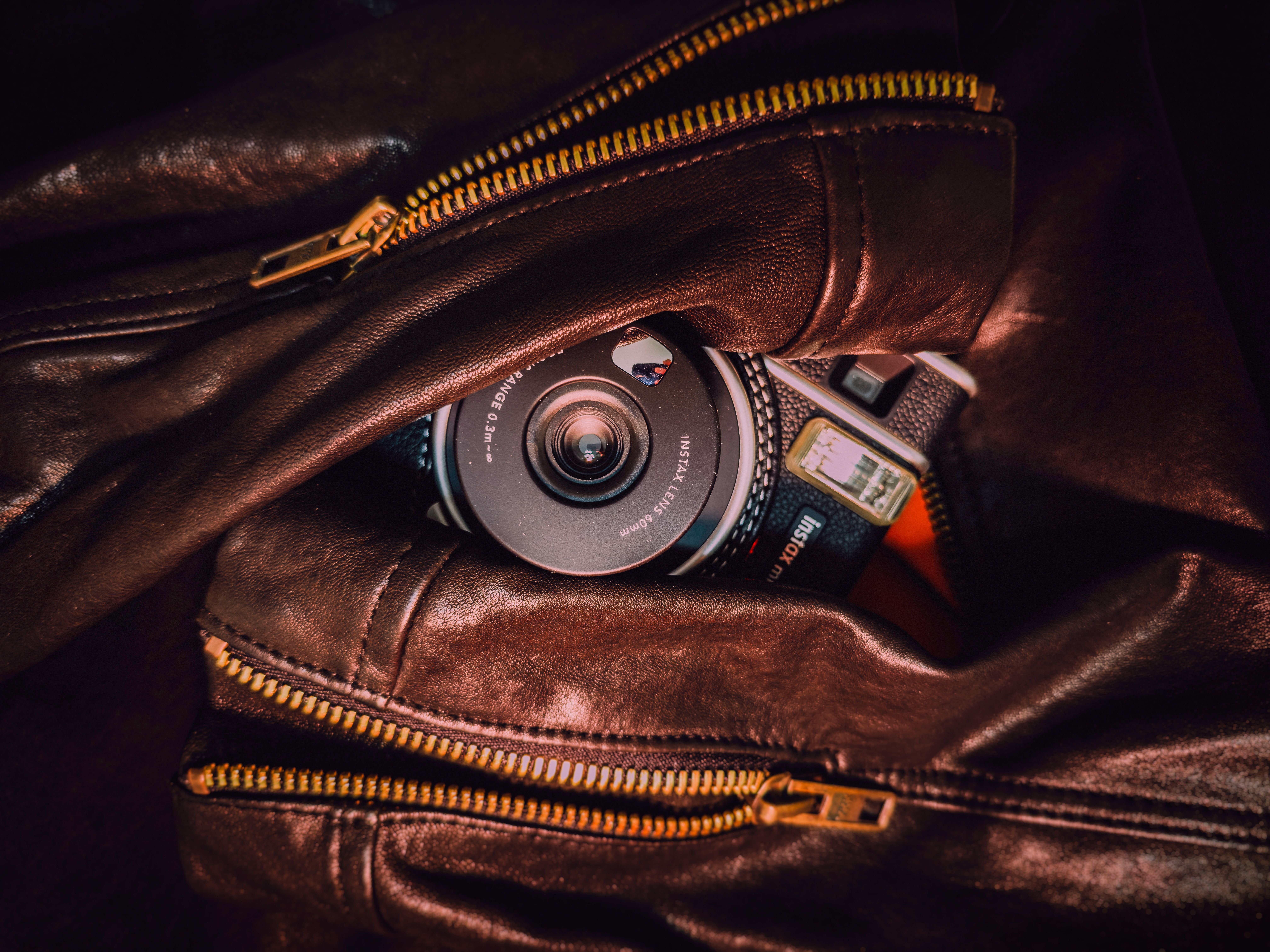 Instax Camera in Leather Jacket · Free Stock Photo