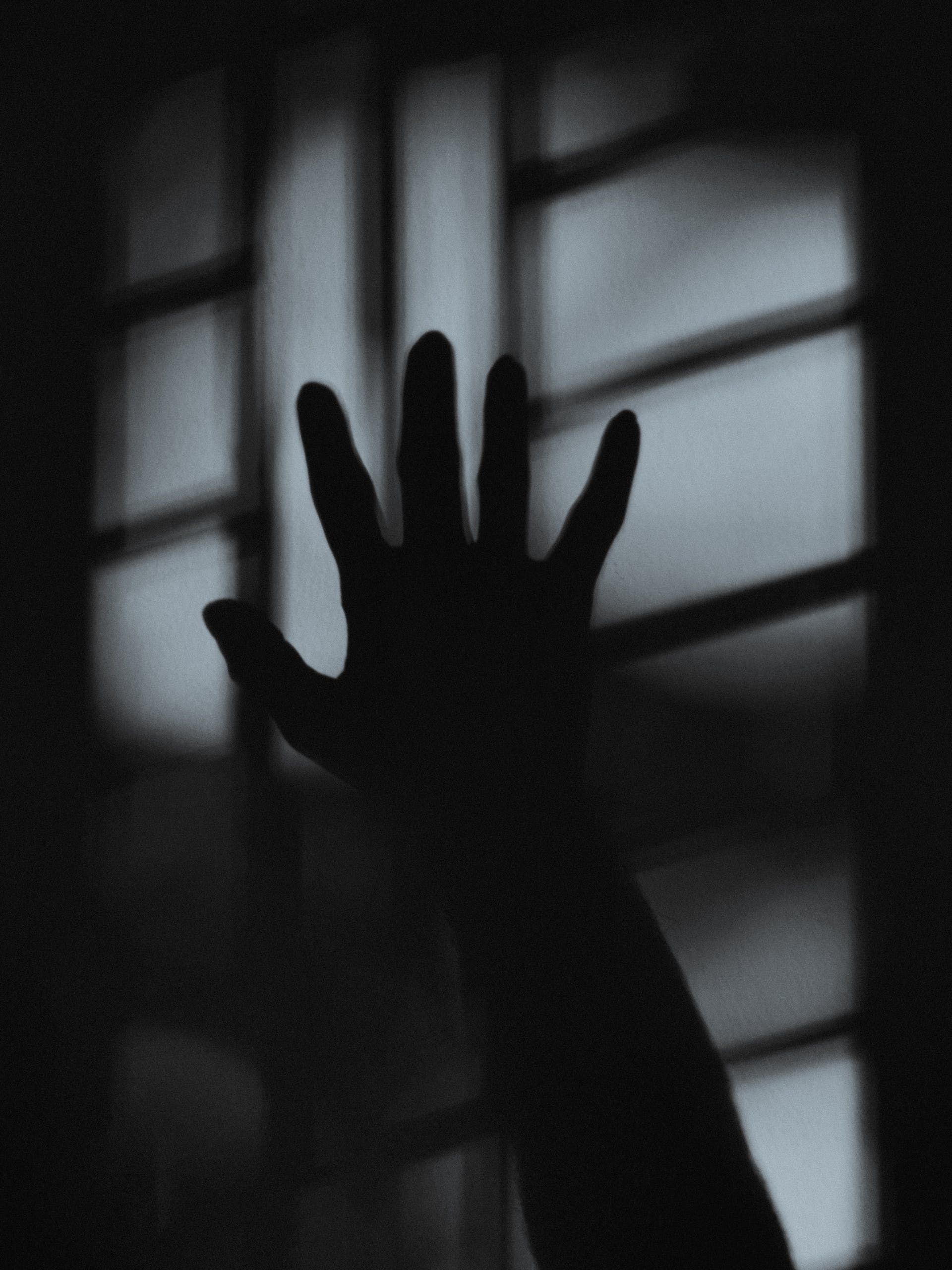 Hand Raised in Darkness · Free Stock Photo