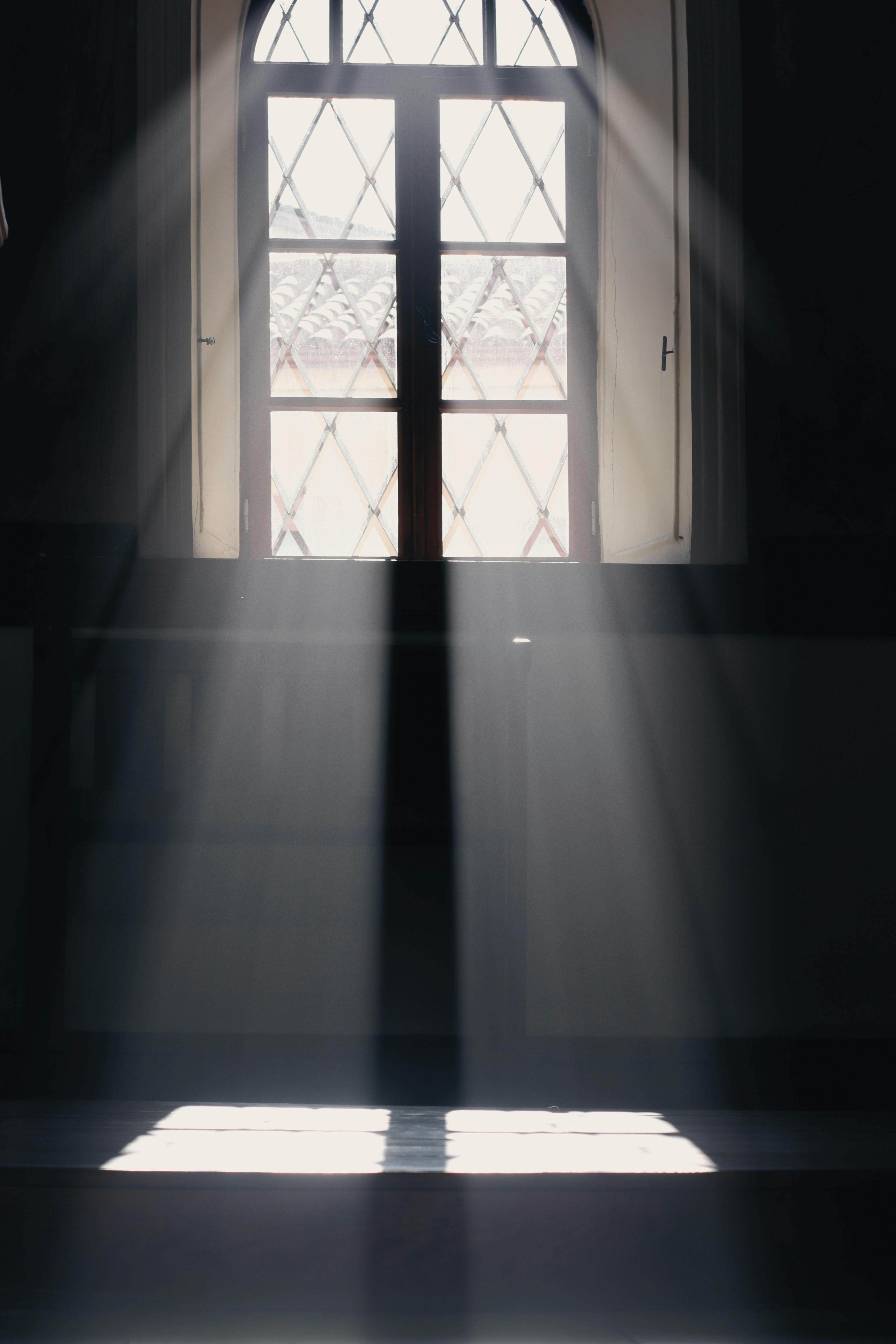 Sunlight shines through a window in a church · Free Stock Photo