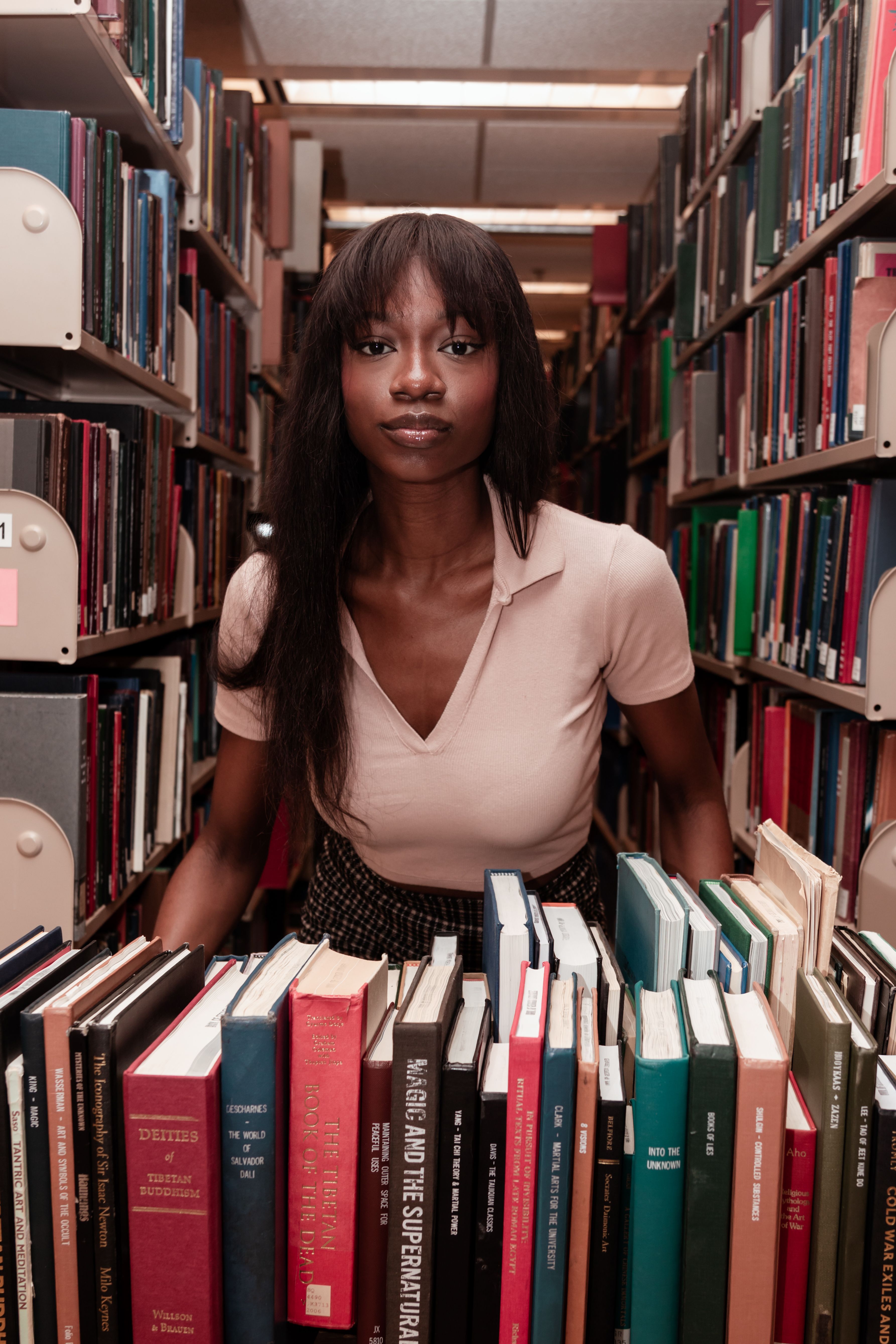 Woman Standing behind Books at Library · Free Stock Photo