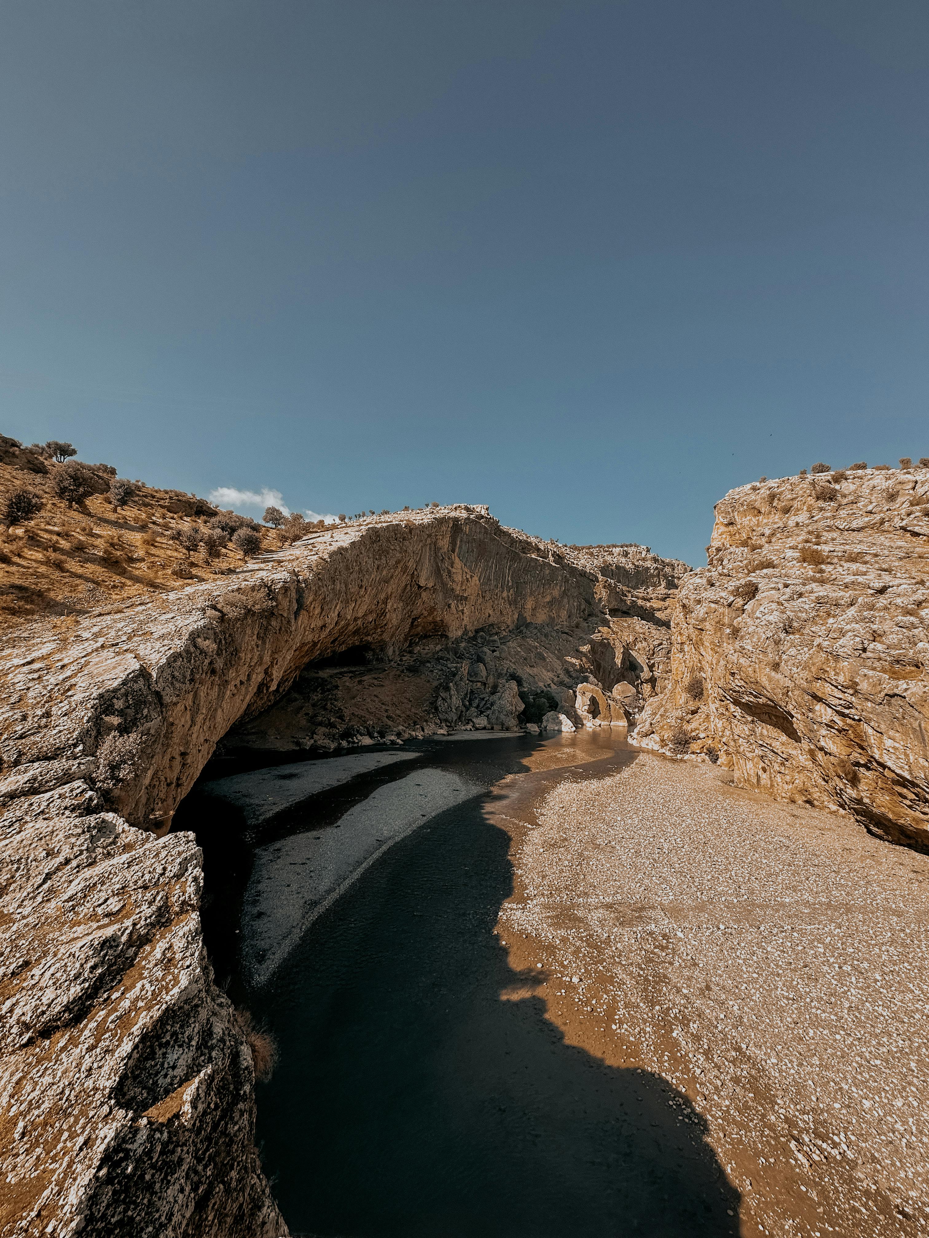 Sunlit Rocks over Cave · Free Stock Photo