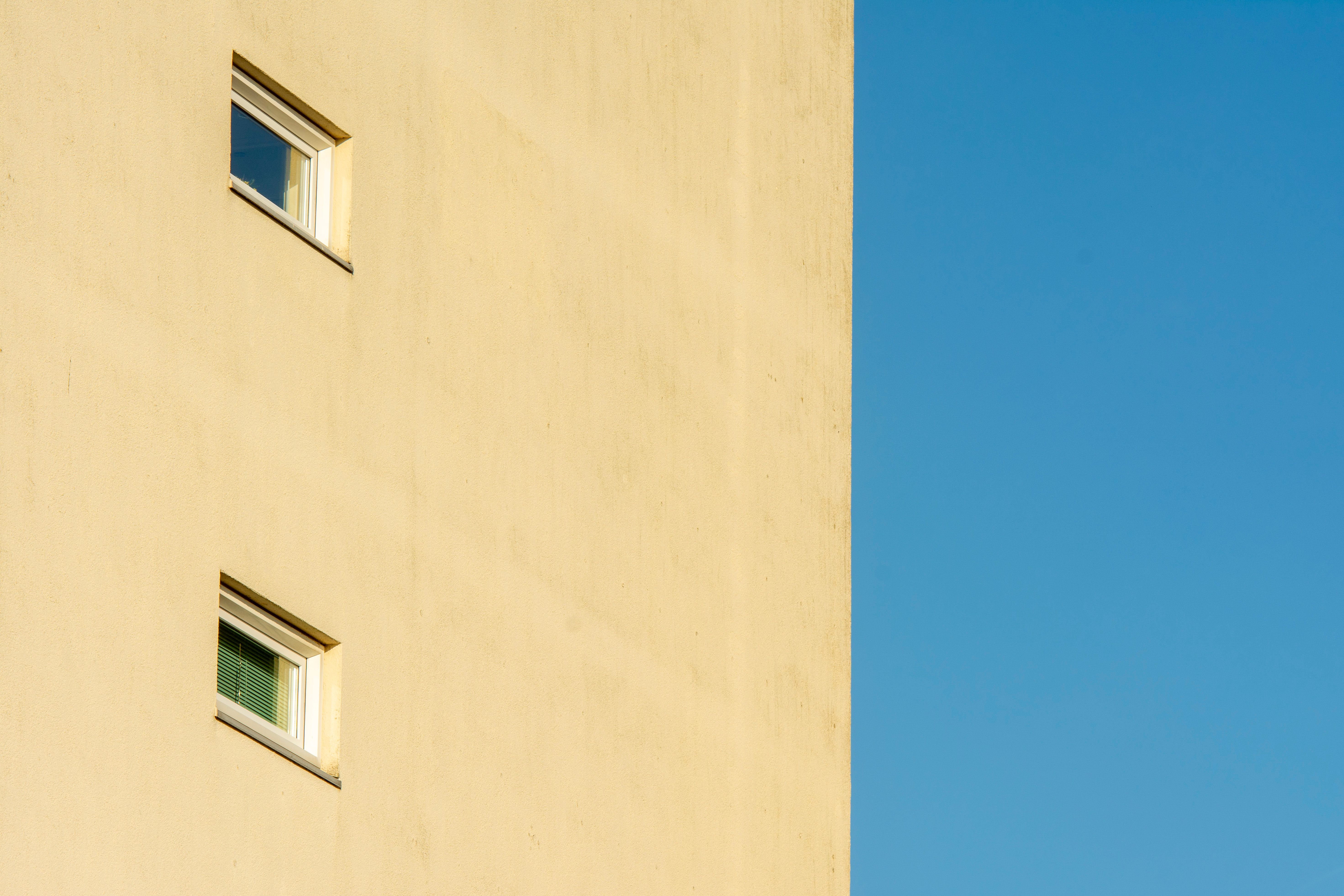 Closeup of Pink Wall with Two Windows · Free Stock Photo