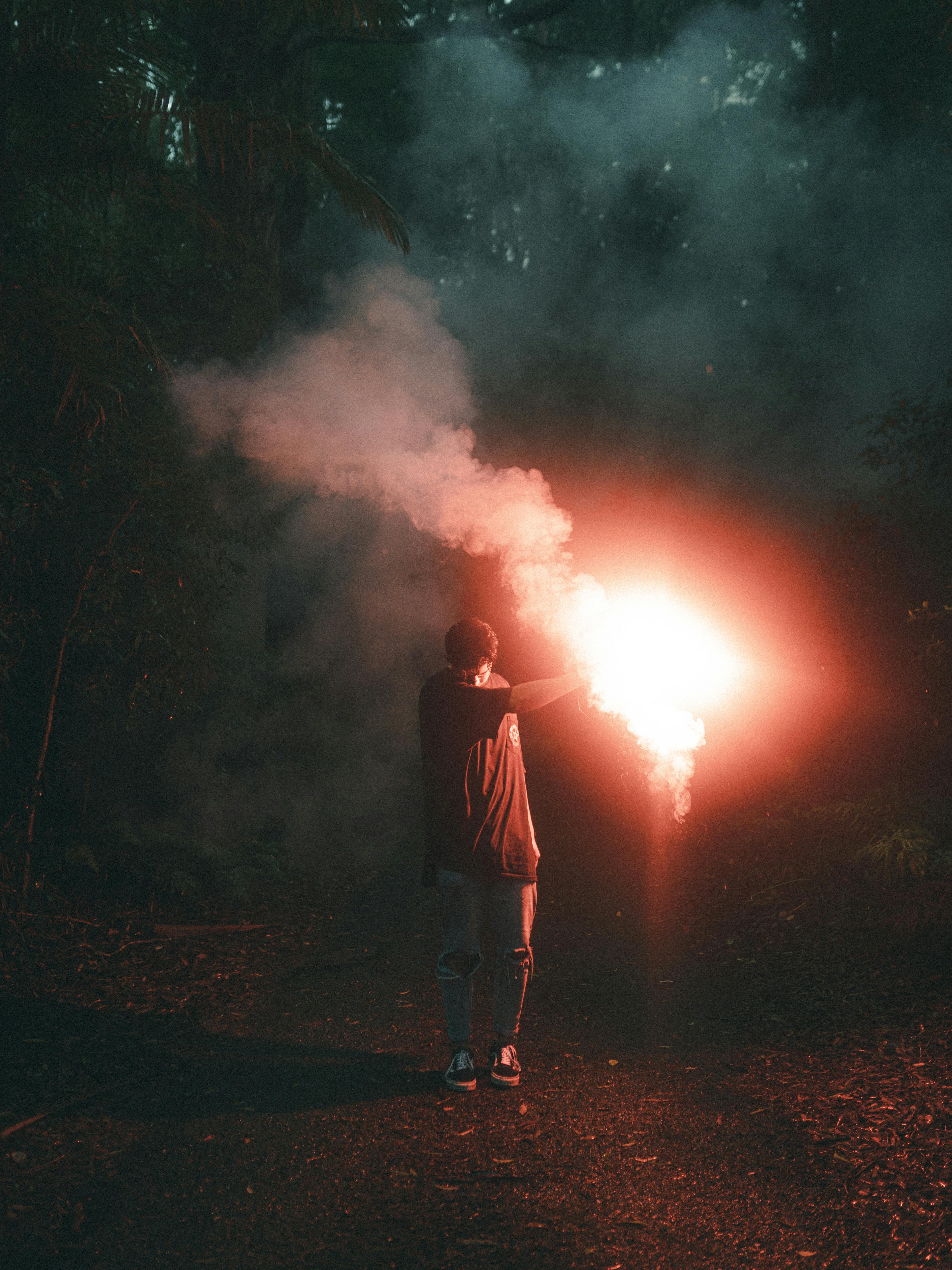 Man with Flare in Forest · Free Stock Photo