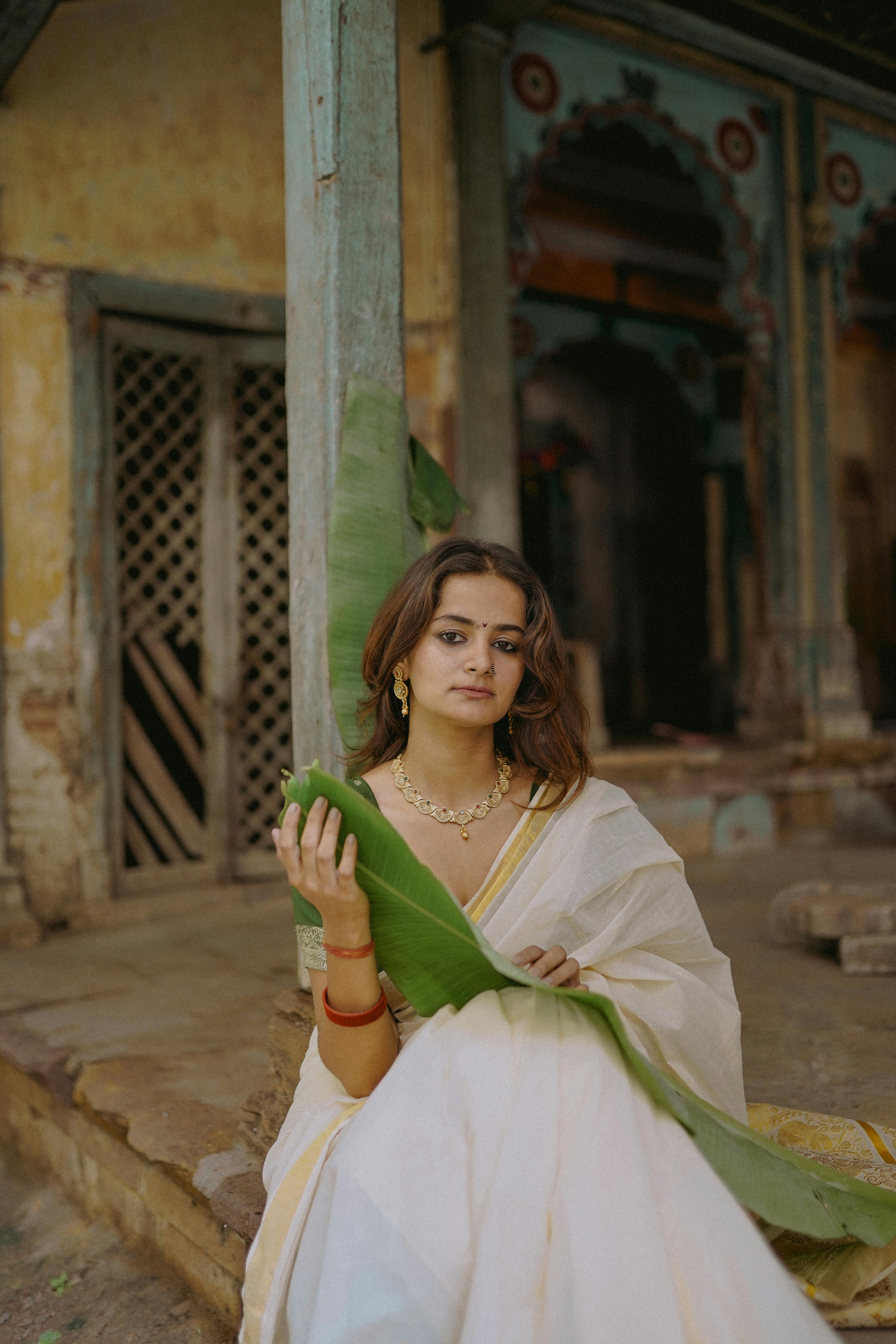 African Woman in Traditional Clothing Sitting and Holding a Calabash ...