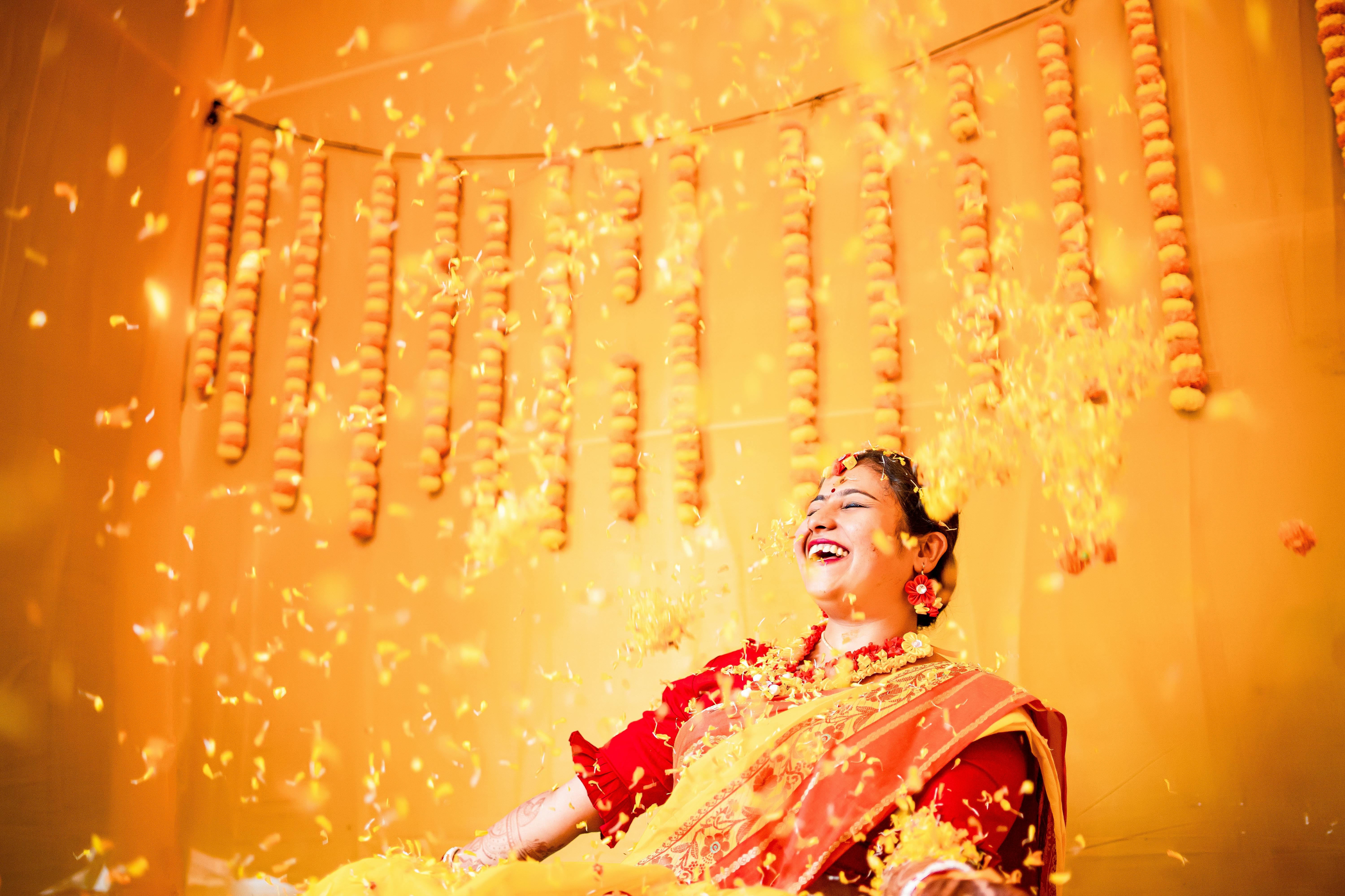Laughing Bride in a Red Saree Among Falling Golden Petals · Free Stock ...