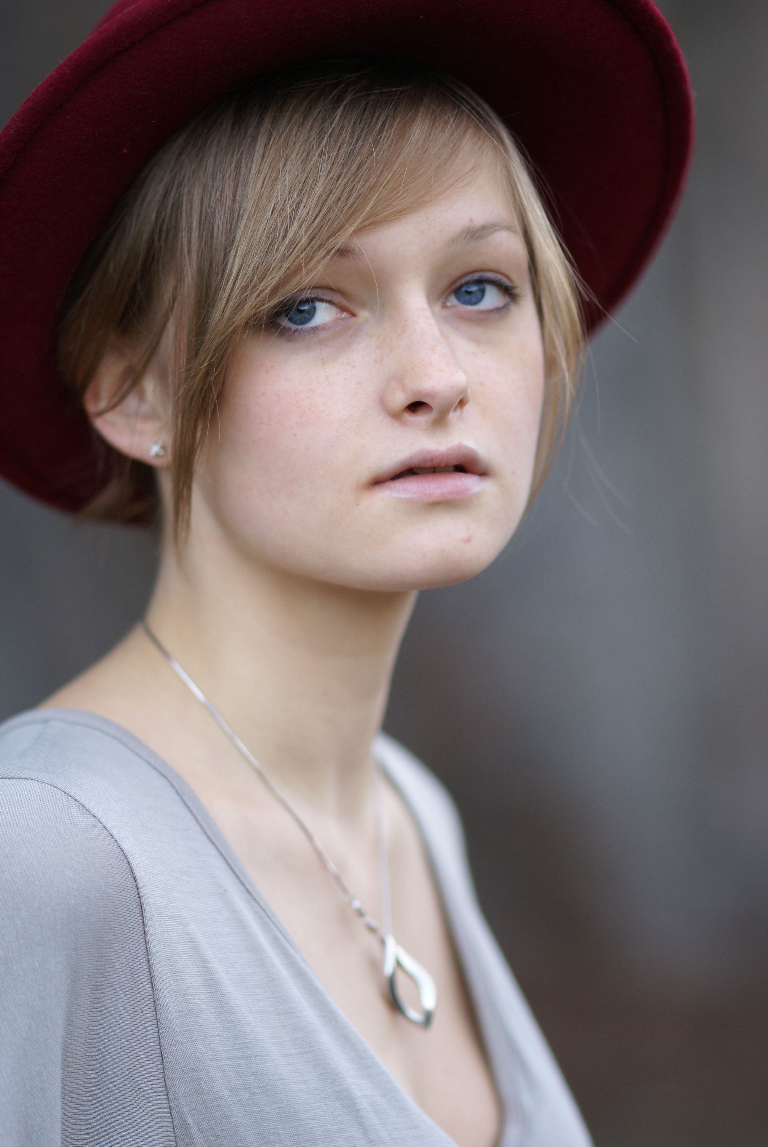 A young woman with a red hat on her head · Free Stock Photo