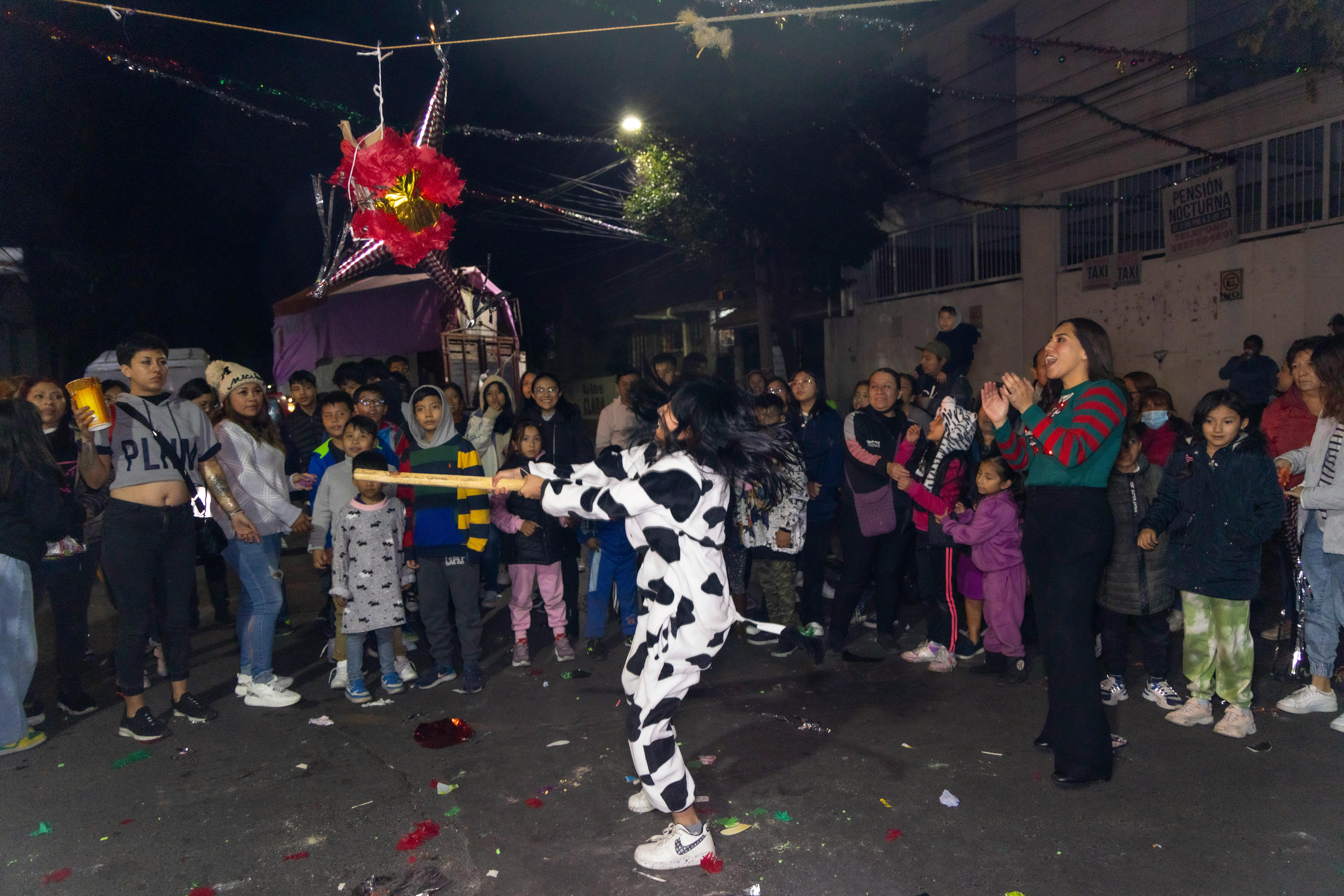 People Watching a Girl Hit a Pinata with a Stick · Free Stock Photo