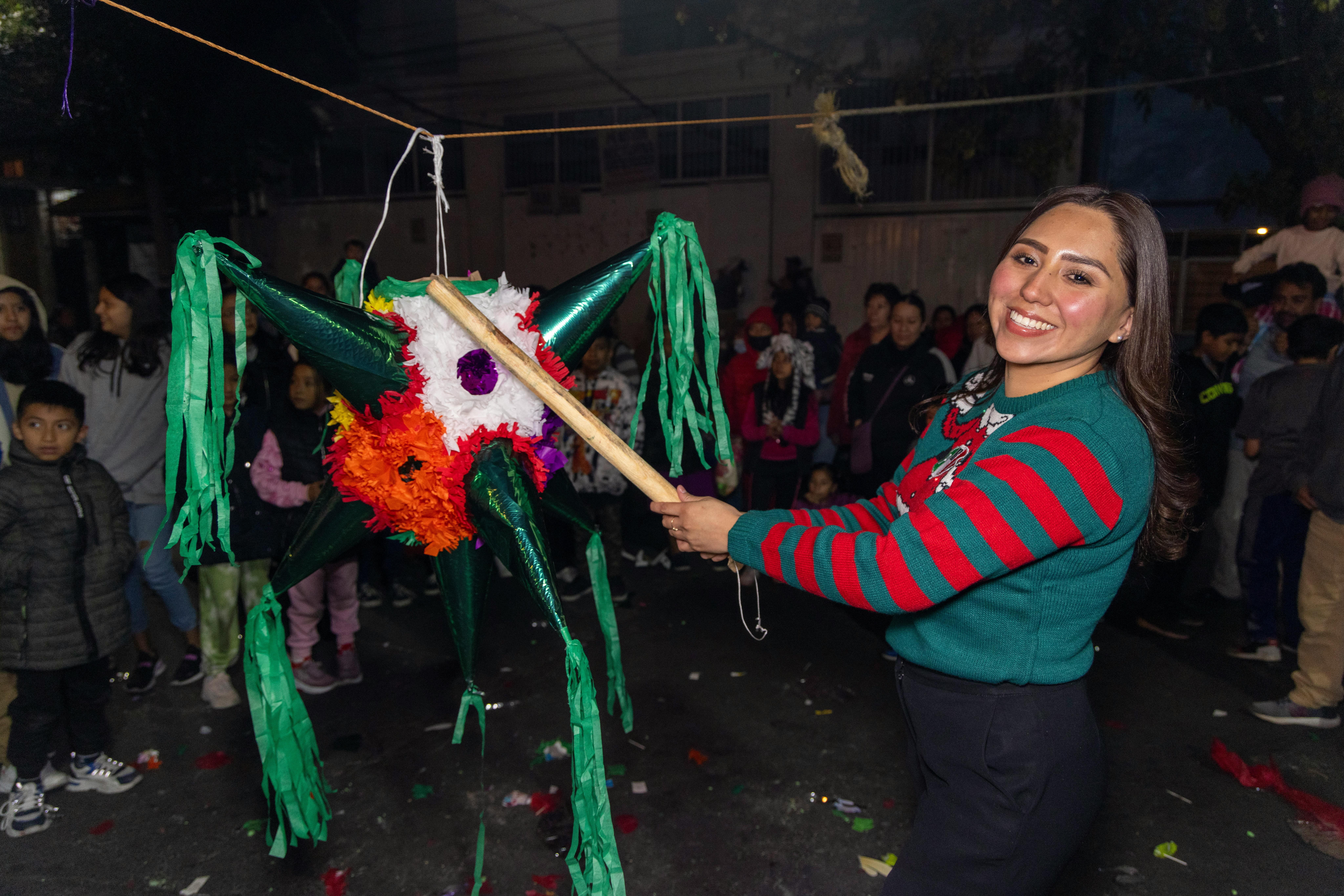 Smiling Woman Hitting Pinata at Night · Free Stock Photo