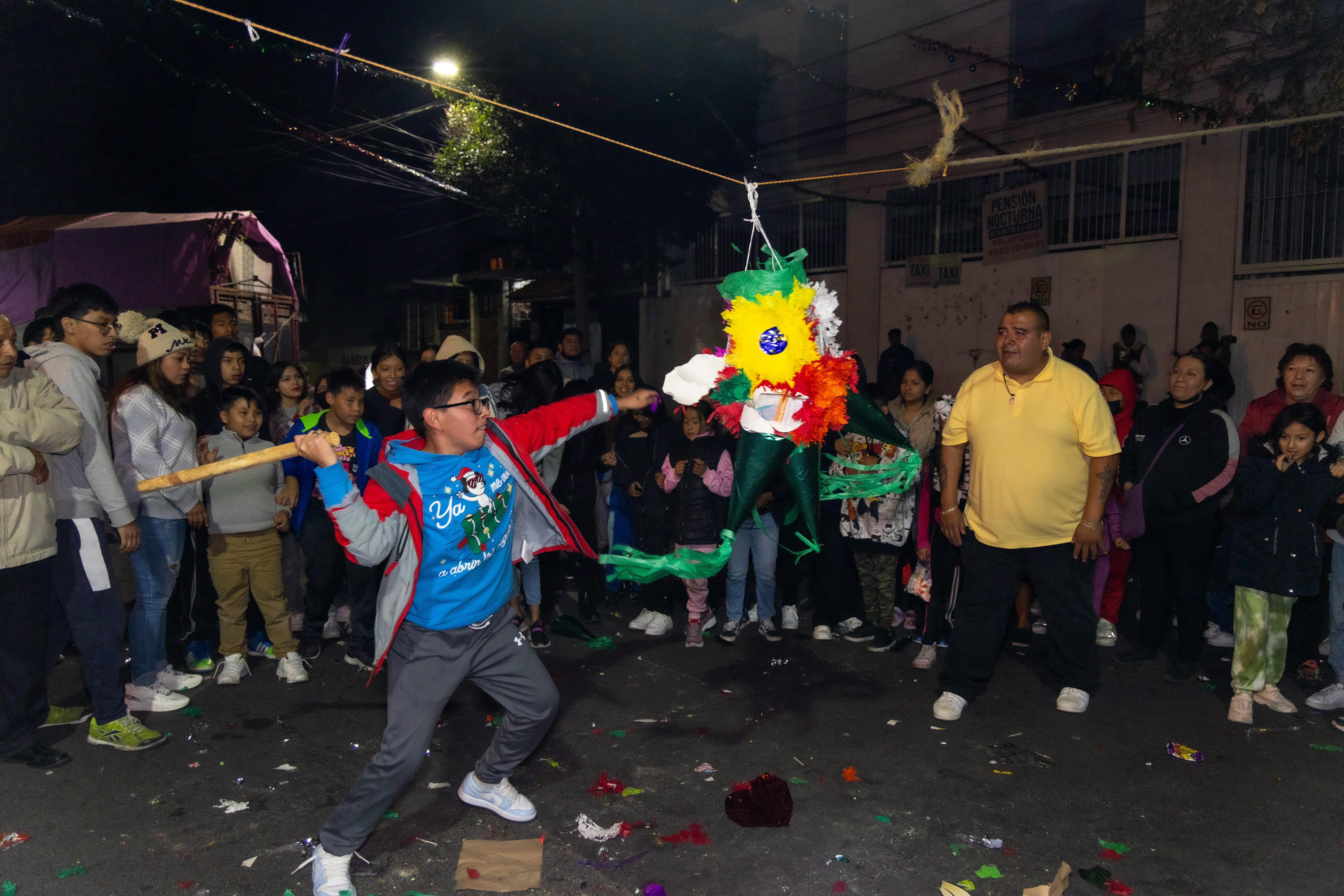 Boy Hitting Pinata at Night · Free Stock Photo