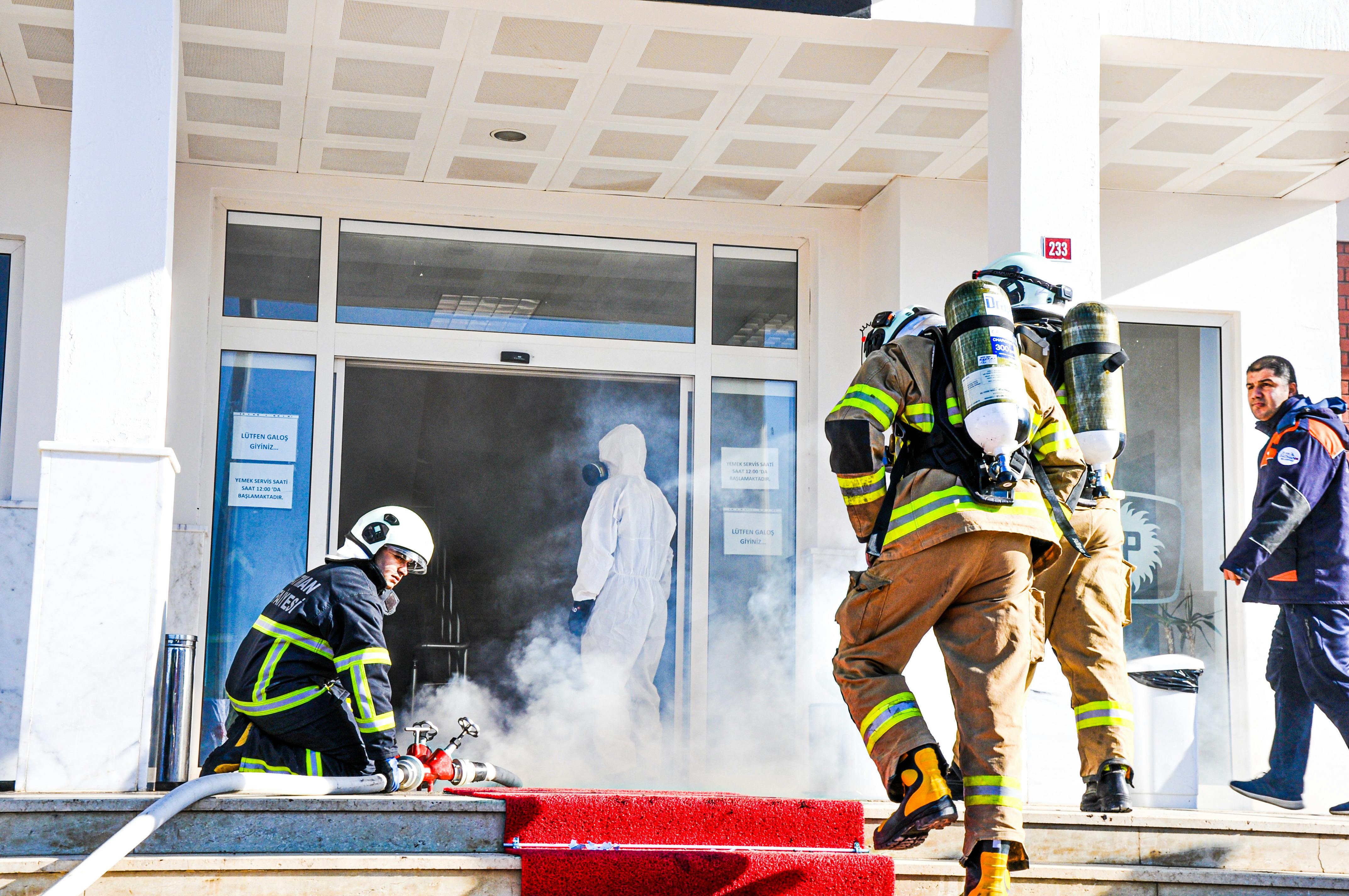 Firefighter Holding Fire Extinguisher · Free Stock Photo