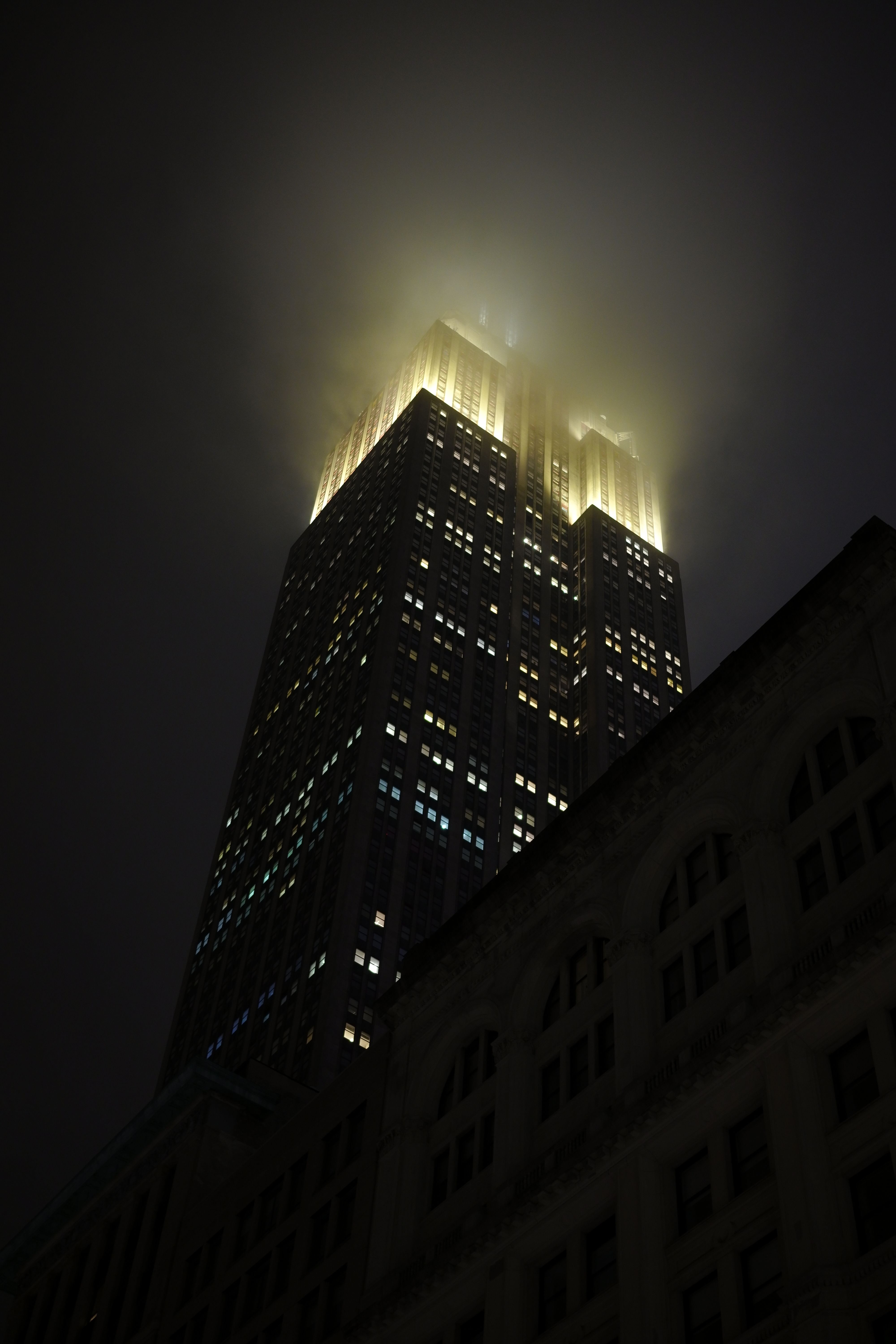 High-rise Building Beside Buildings during Night · Free Stock Photo