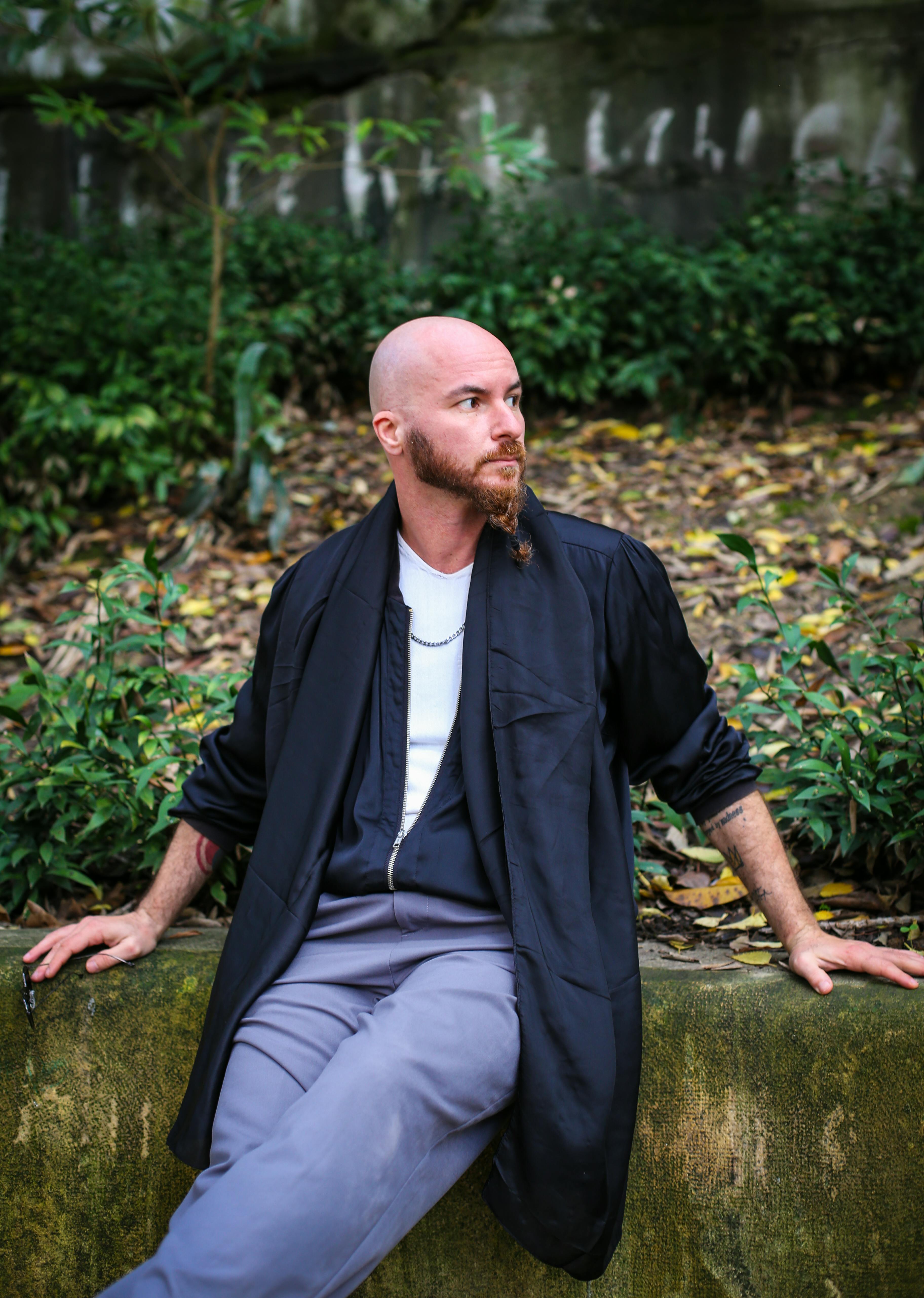 A Bald Man with a Bard Sitting in Park and Looking Away · Free Stock Photo
