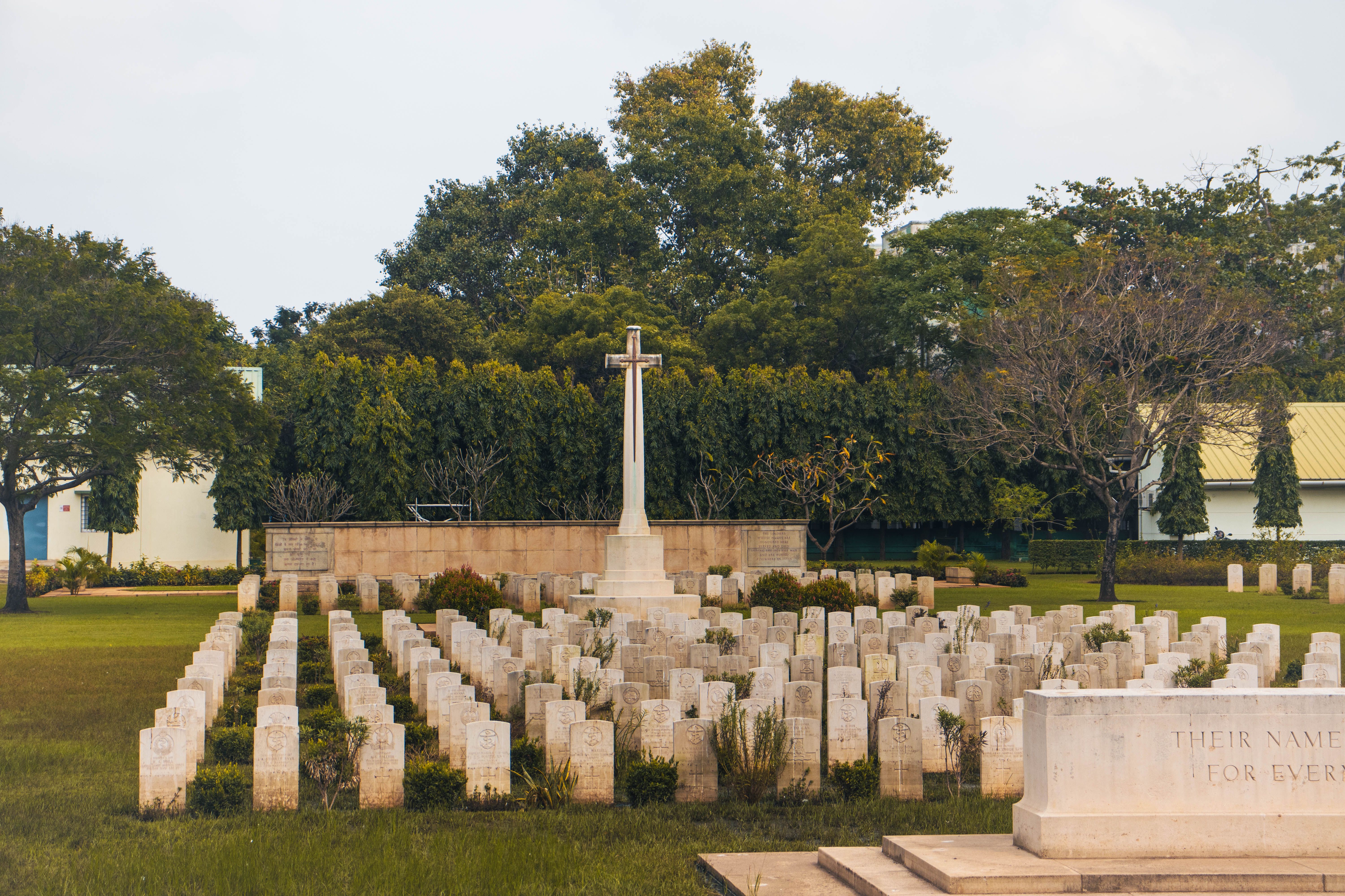 Tombstones and Cross in Cemetery · Free Stock Photo