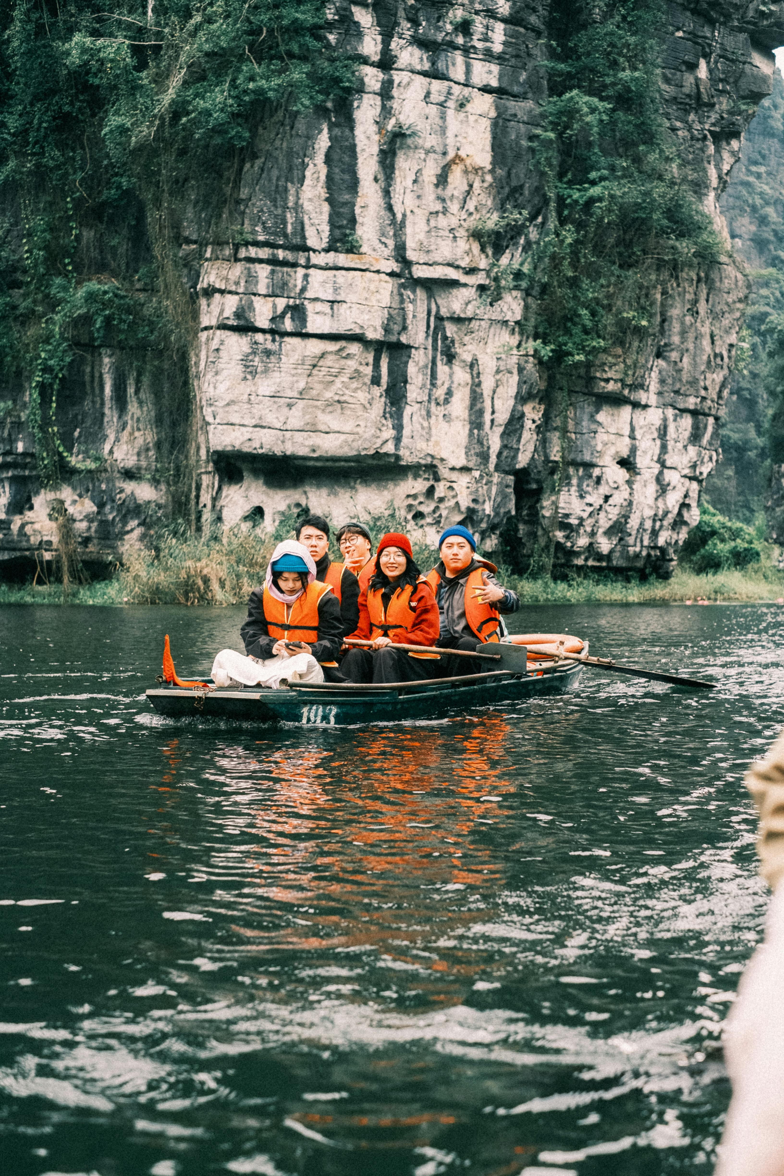 People on Boat Crossing River between Rock Formations · Free Stock Photo