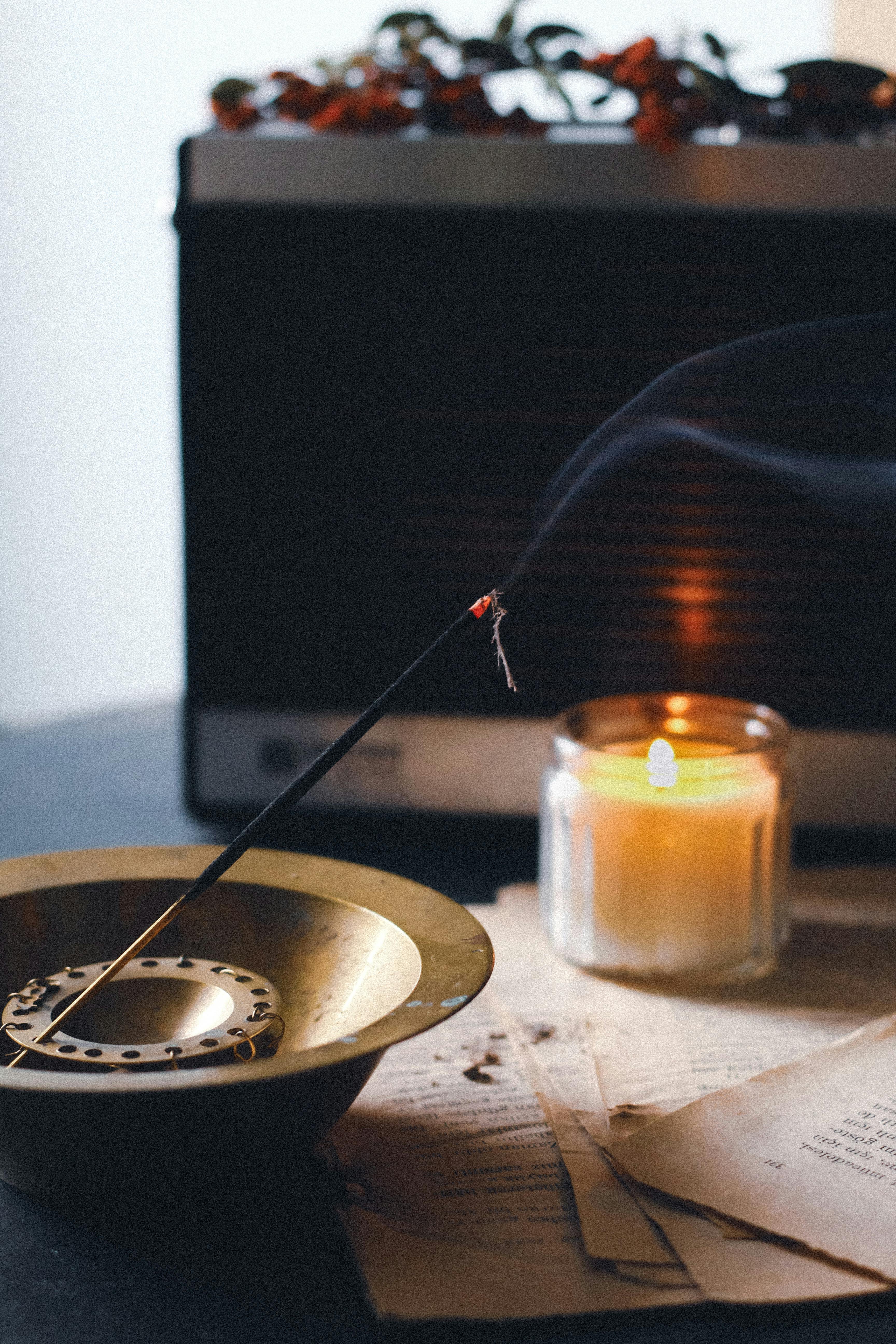 Close-up of a Burning Candle and Incense Stick · Free Stock Photo