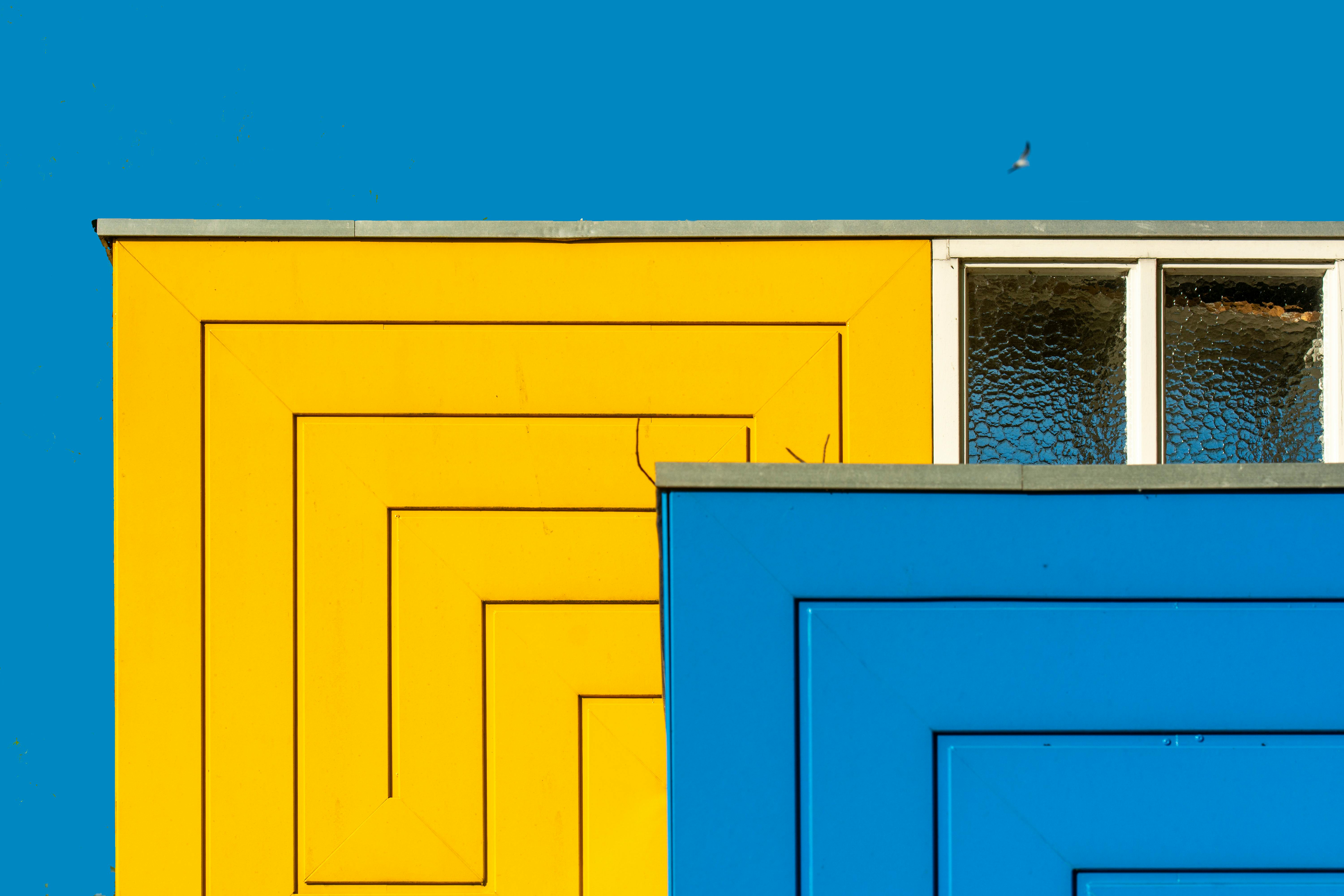Close-up of a Bright Blue and Yellow Building against Blue Sky · Free ...