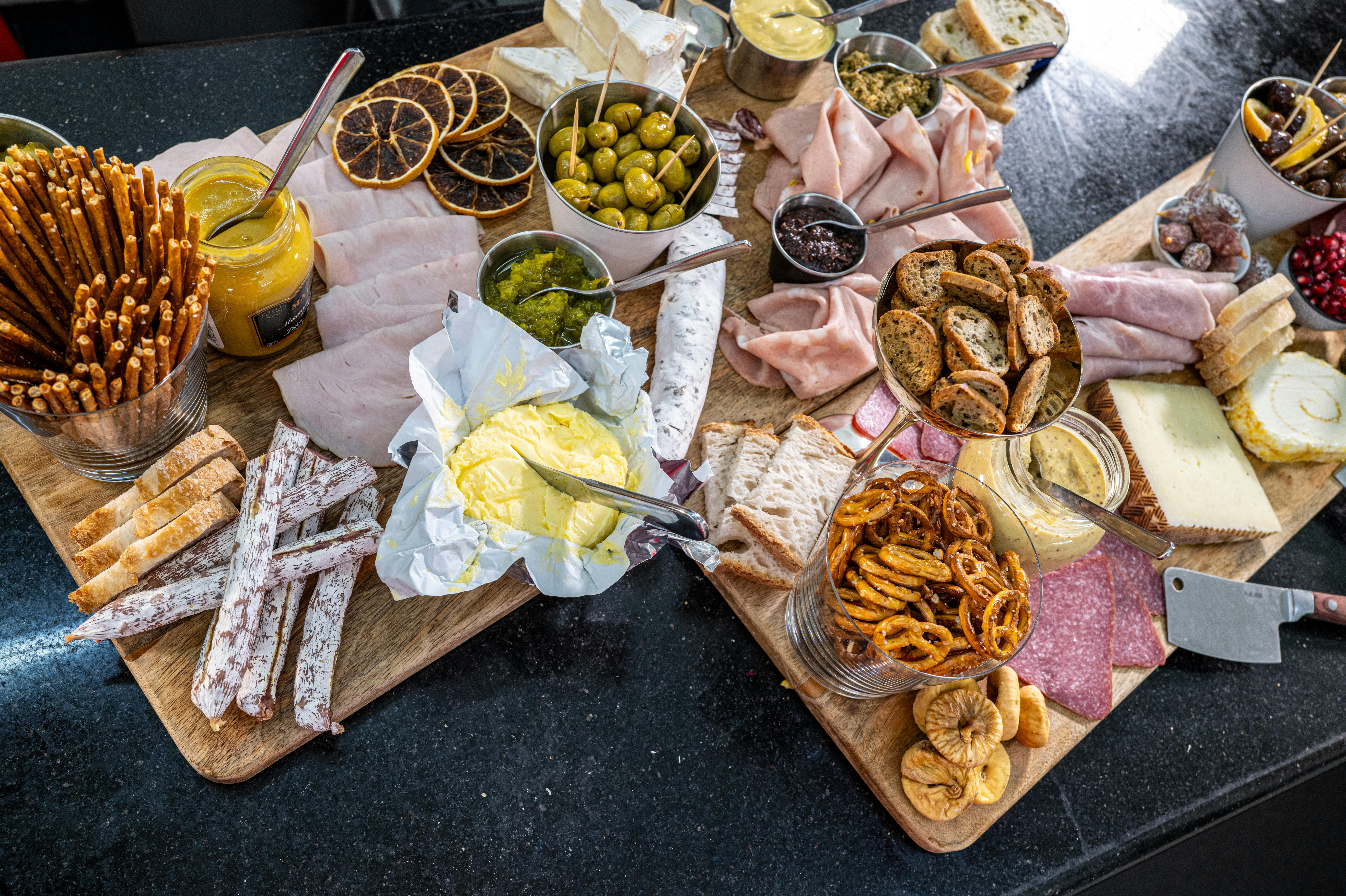 Buffet with Meat, Cheese, Pesto, Salty Snacks and Olives · Free Stock Photo