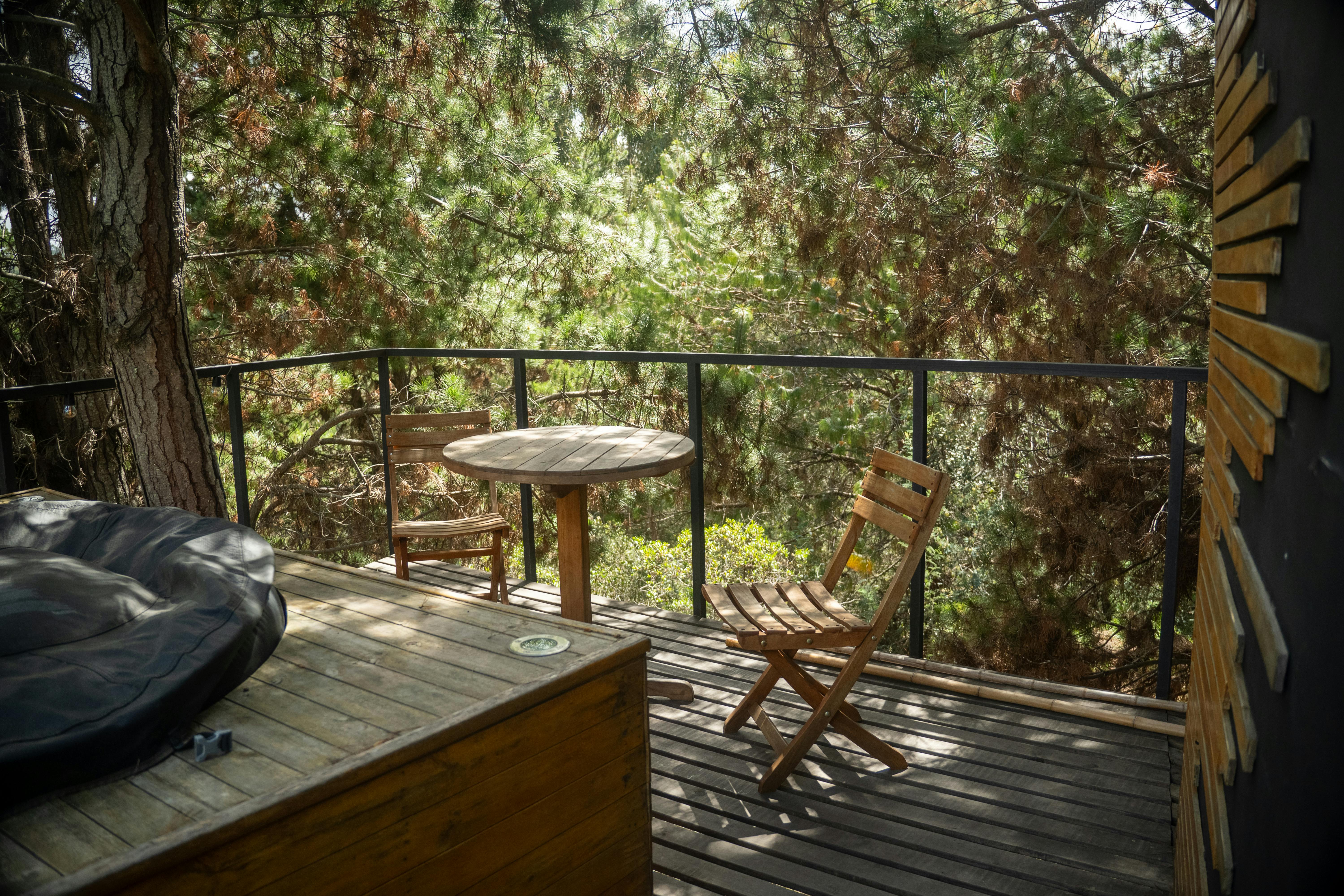 A Jacuzzi, Table and Chairs on a Terrace with View of Trees · Free ...