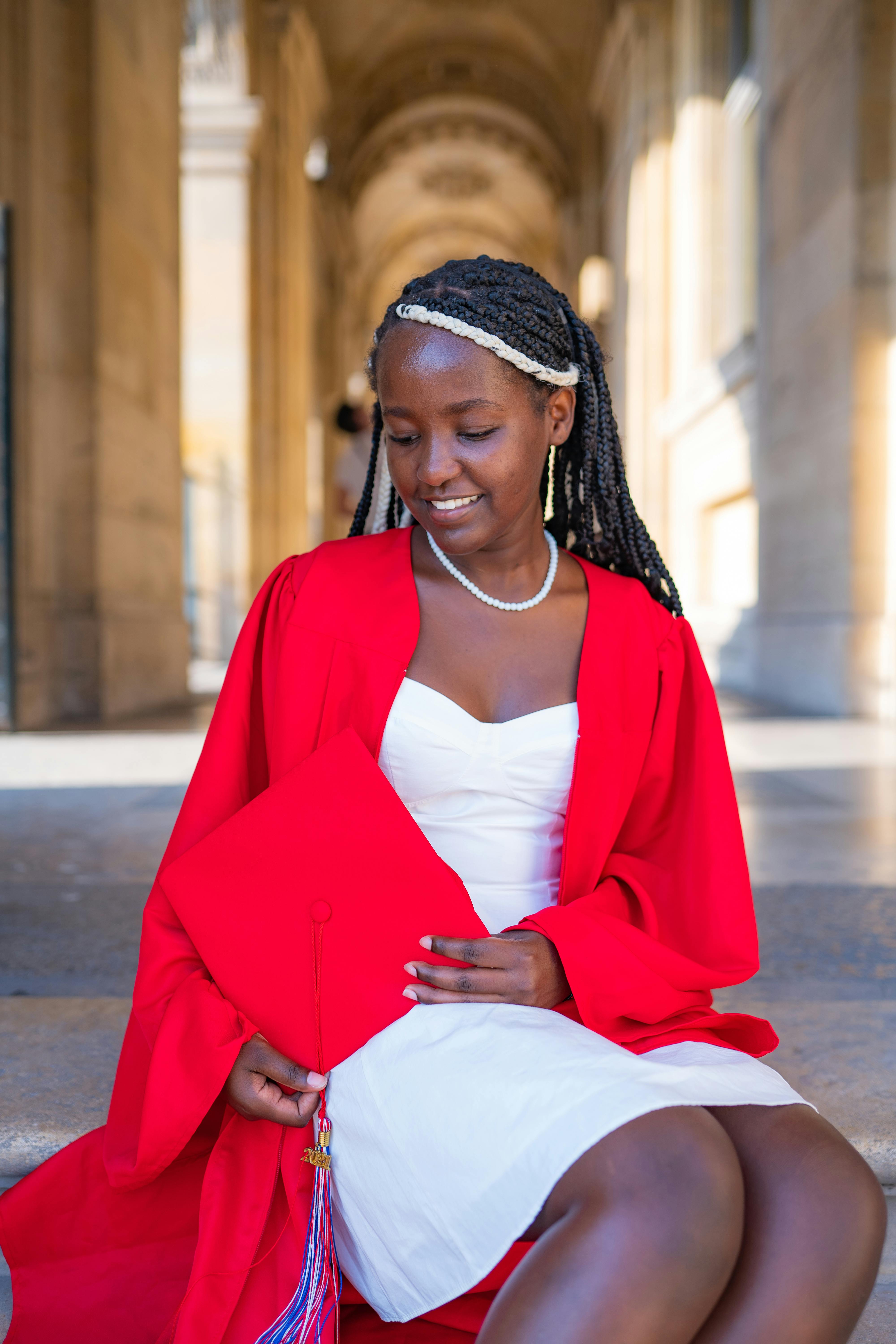 Graduate Woman Sitting in White Dress and Red Academic Gown · Free ...