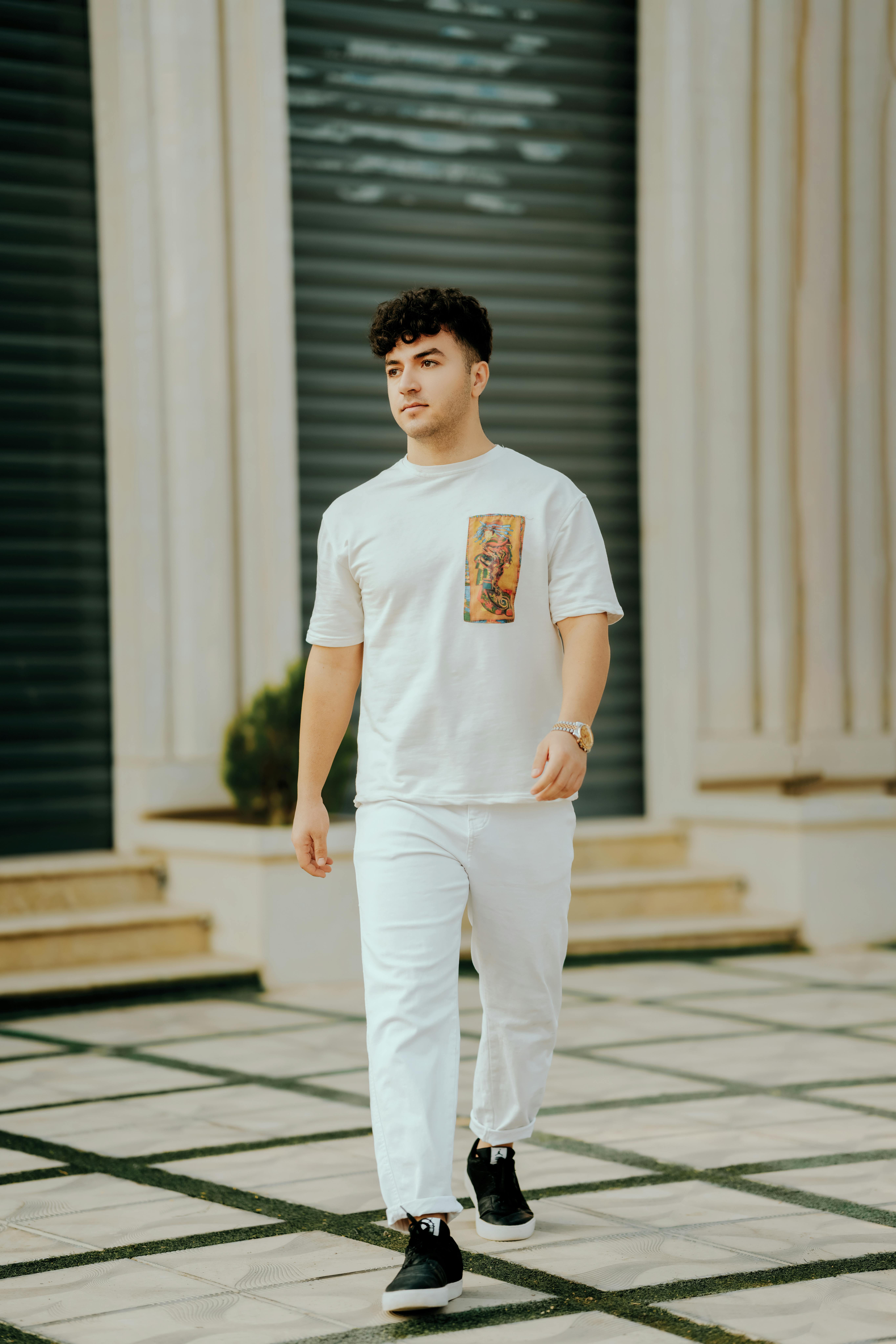Man Wearing White Clothes Walking on a Street · Free Stock Photo