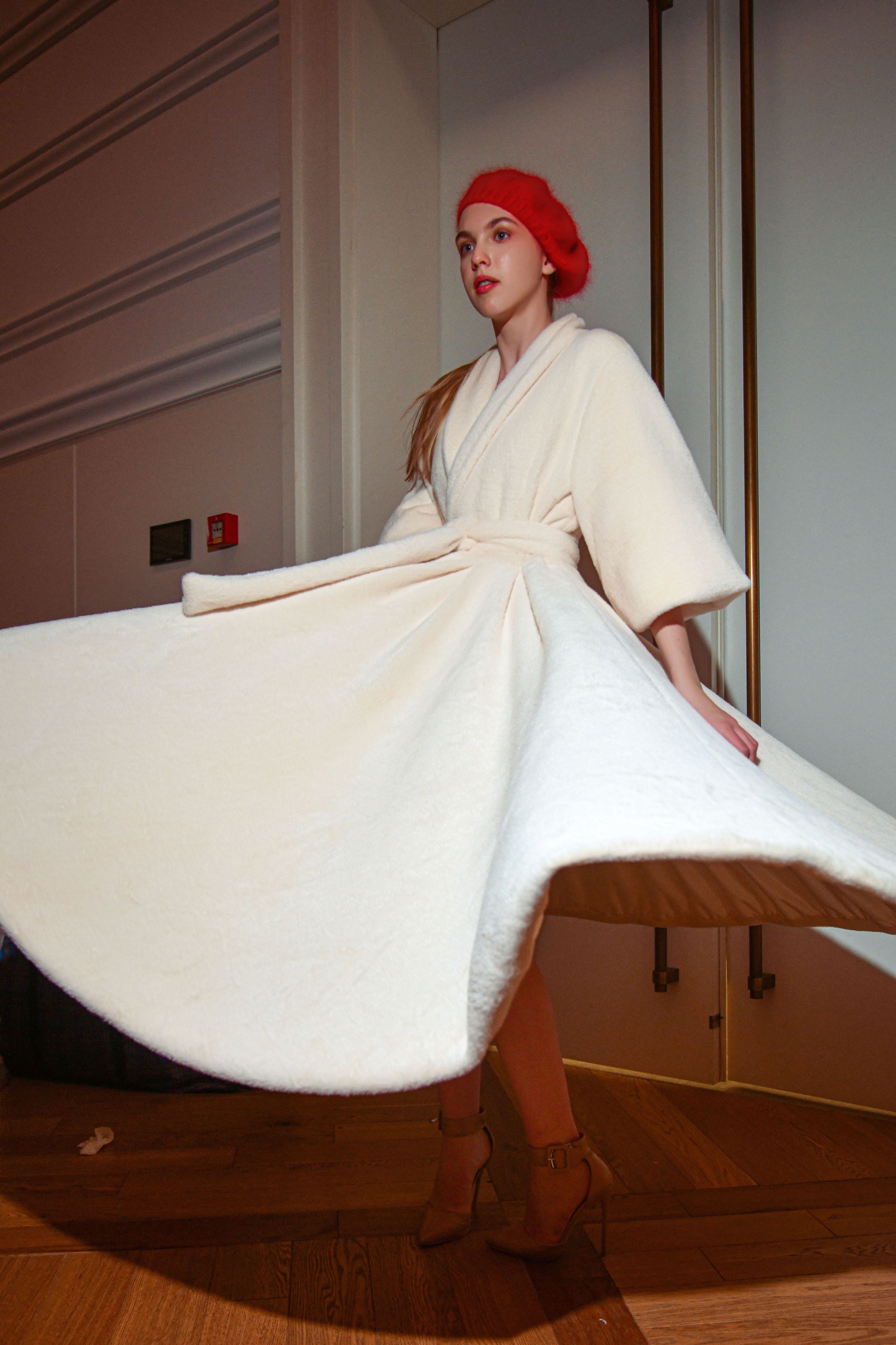 Woman Wearing A White Dress Red Hat And Heels Spinning In A Room 6285