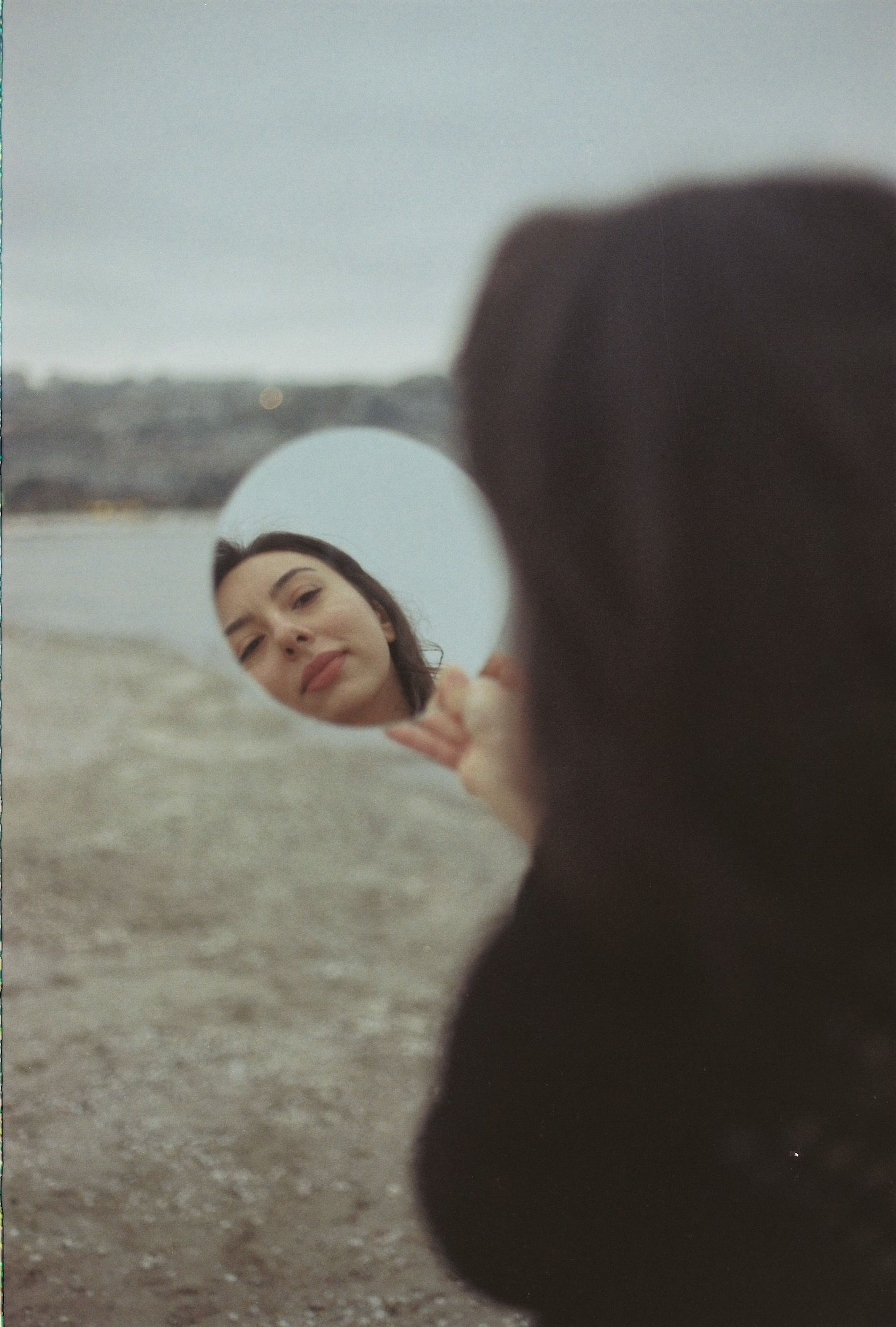 Womans Shoulder and Face in Mirror Reflection · Free Stock Photo
