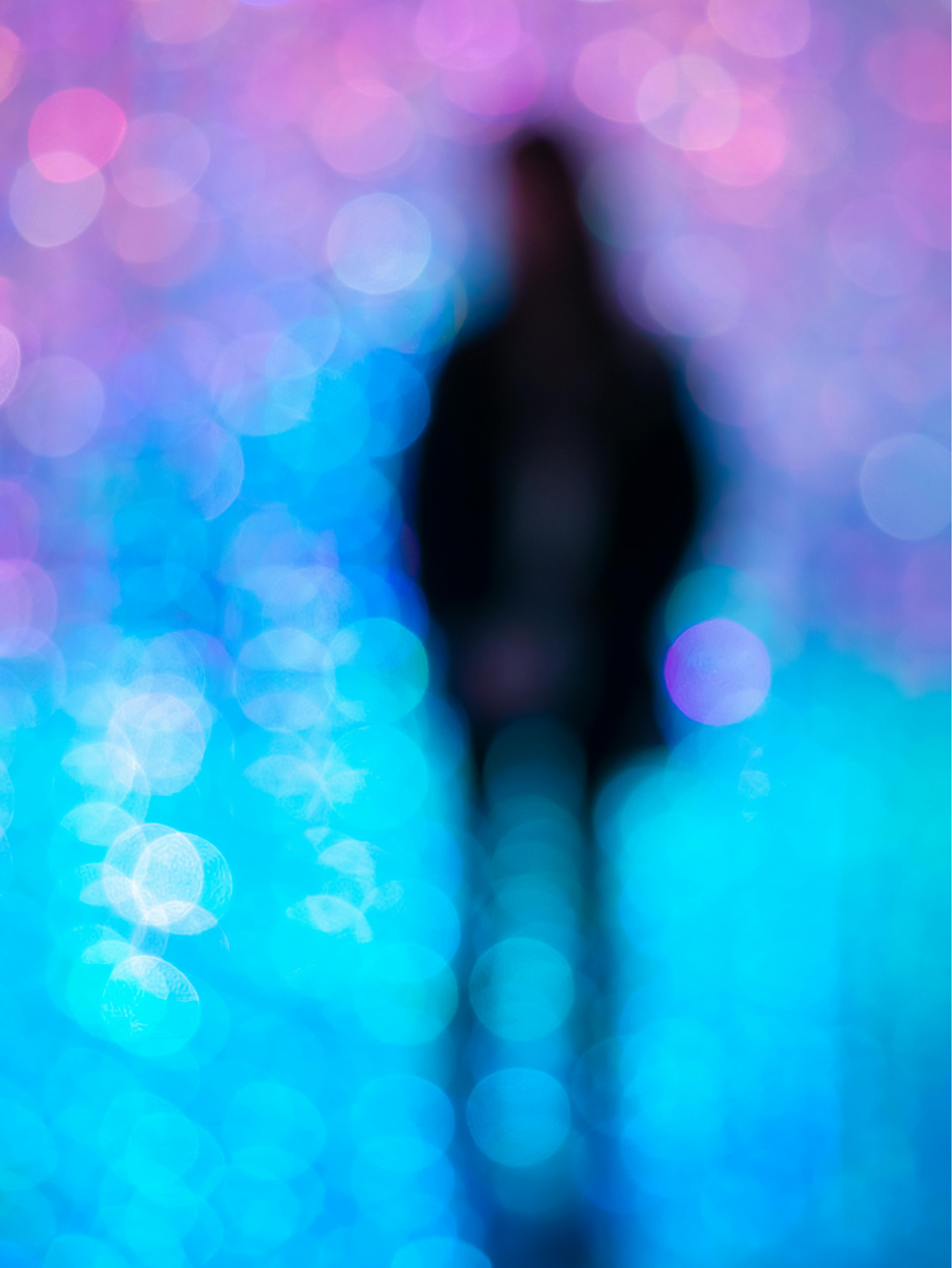 Blurred Model Standing on Purple and Blue Background · Free Stock Photo