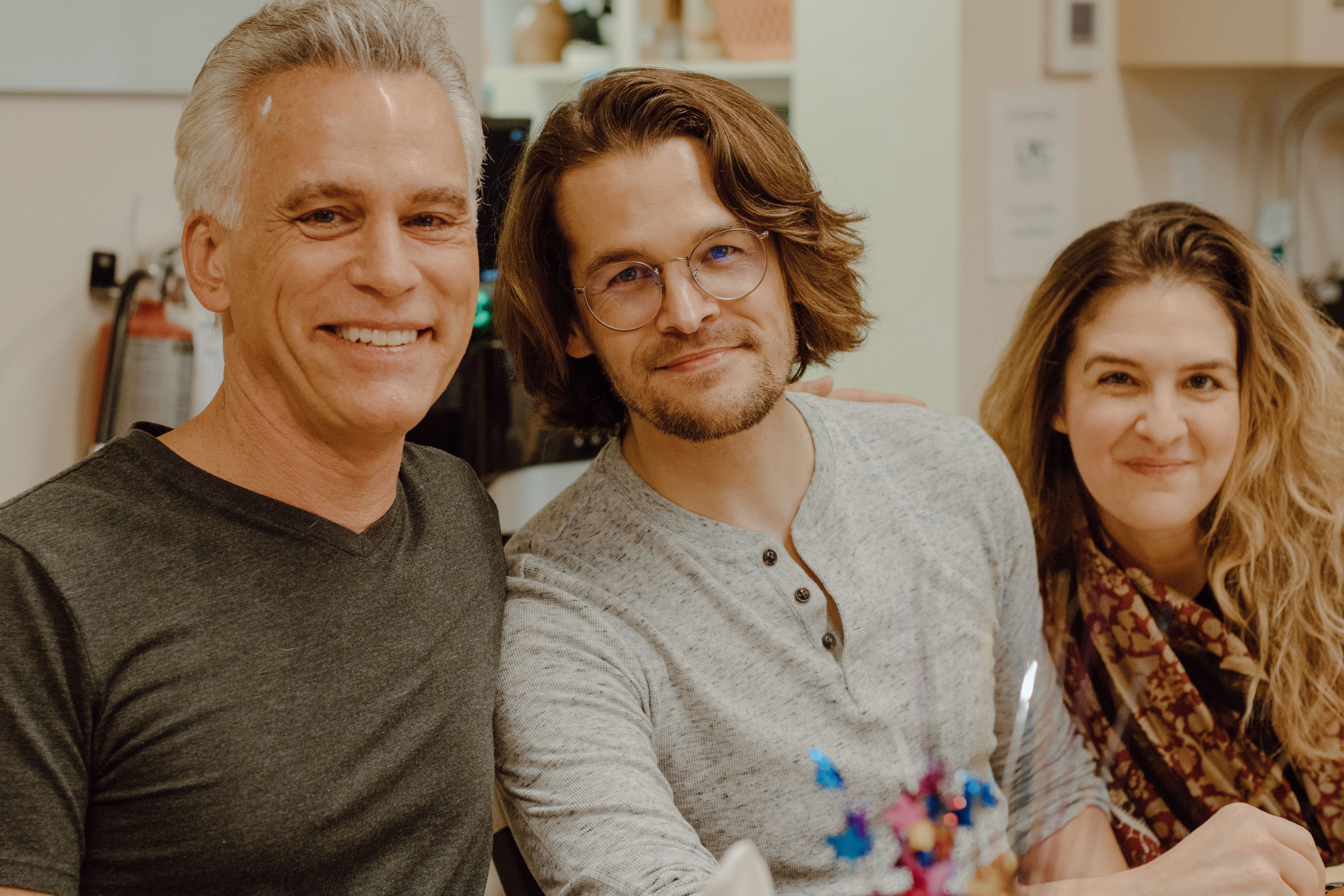 Smiling People Sitting in Row at Celebration · Free Stock Photo