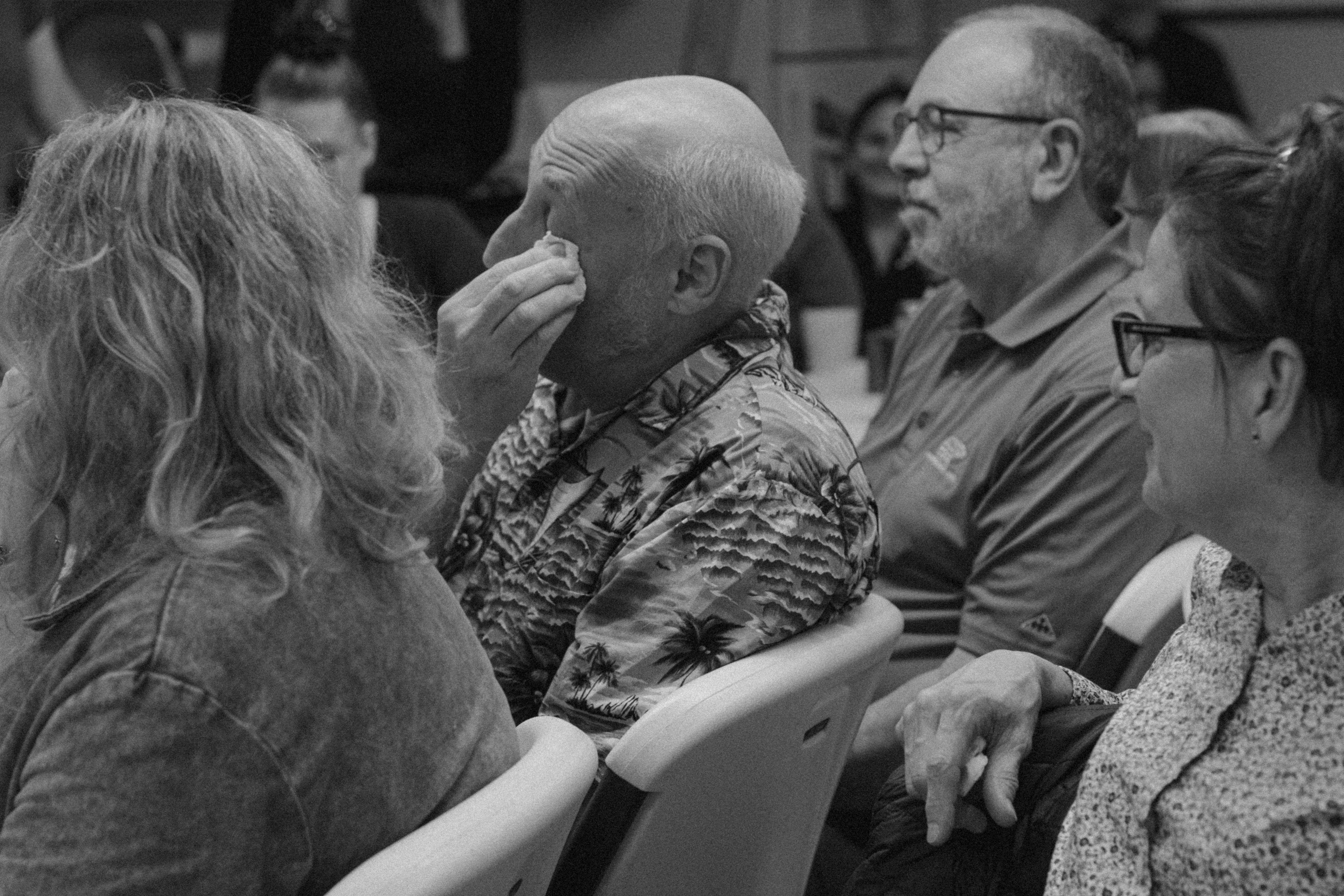 Elderly Man Crying Sitting on Chair in Row at Gathering · Free Stock Photo