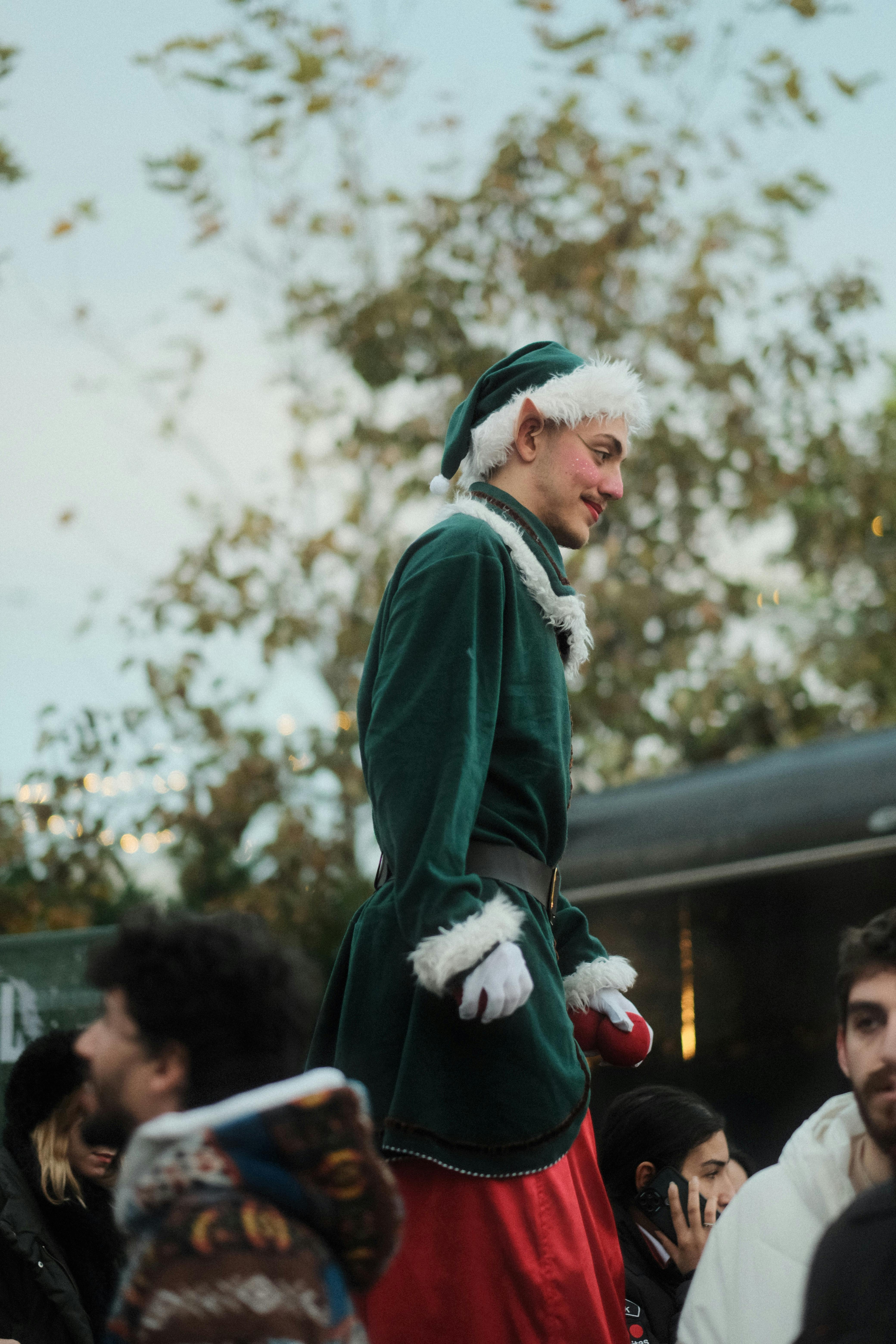 Santas Elf Walking Through a Crowd of People · Free Stock Photo
