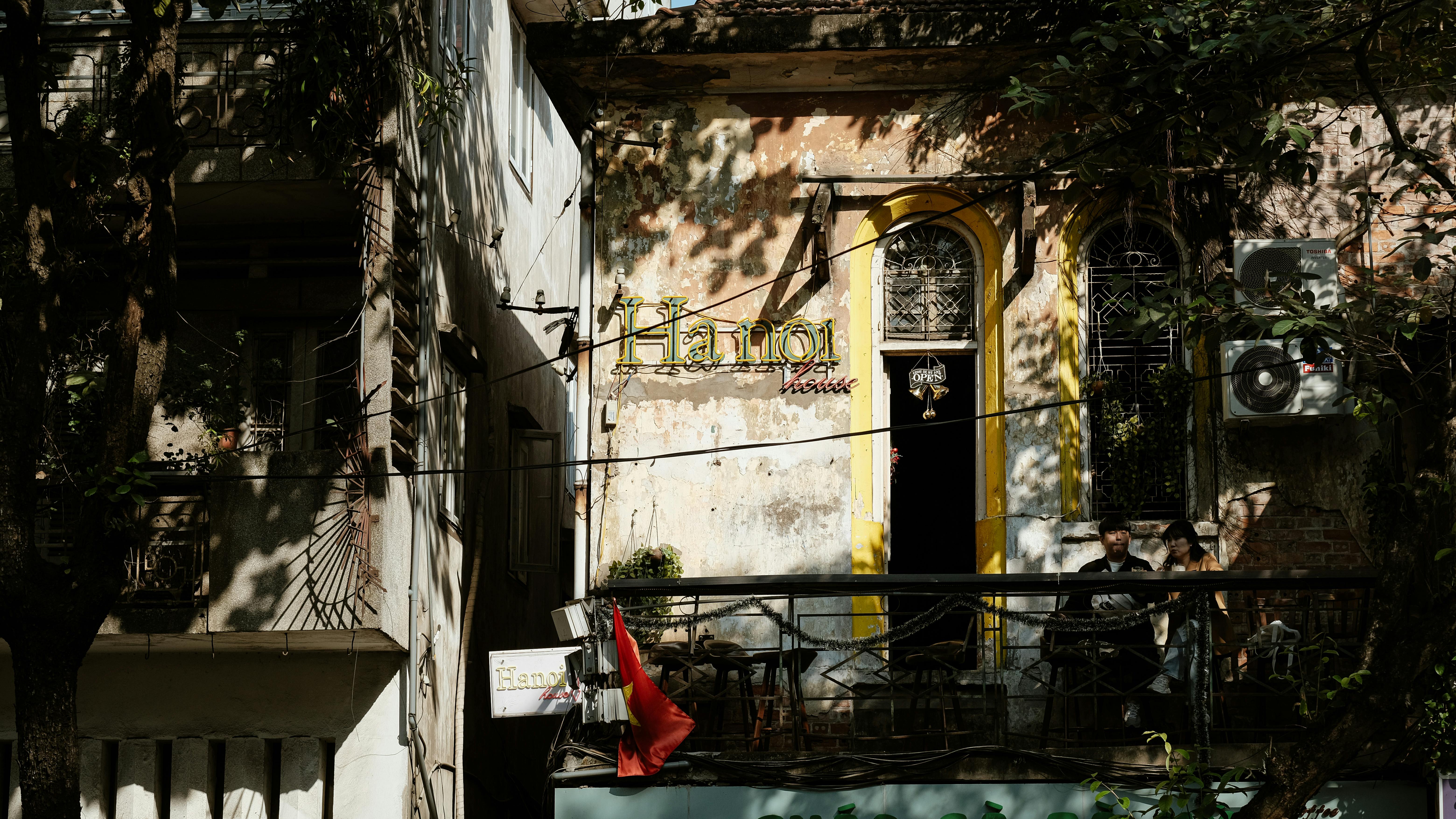 Logo on Building Wall in Shadow · Free Stock Photo