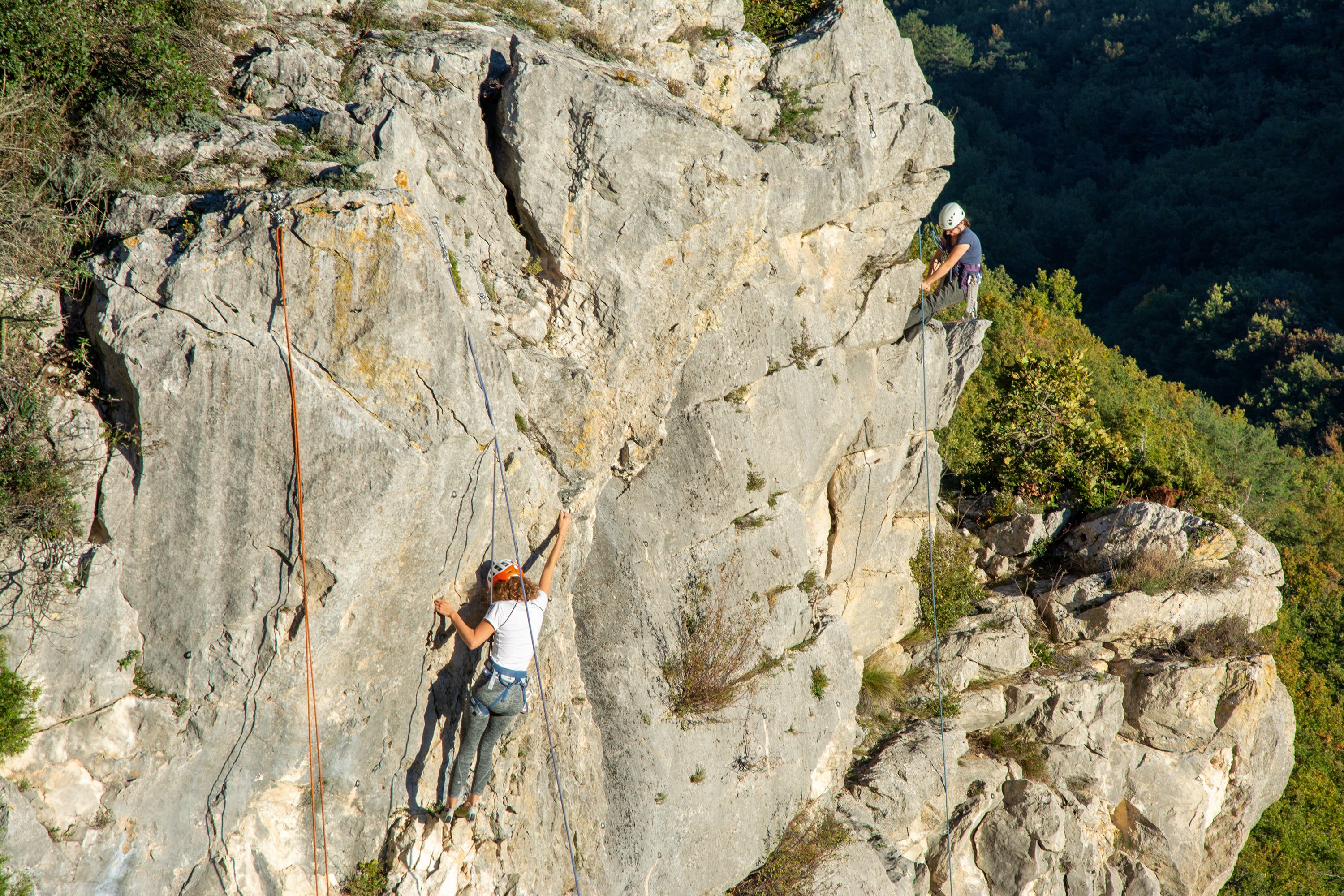 Two climbers are climbing on a rock face · Free Stock Photo