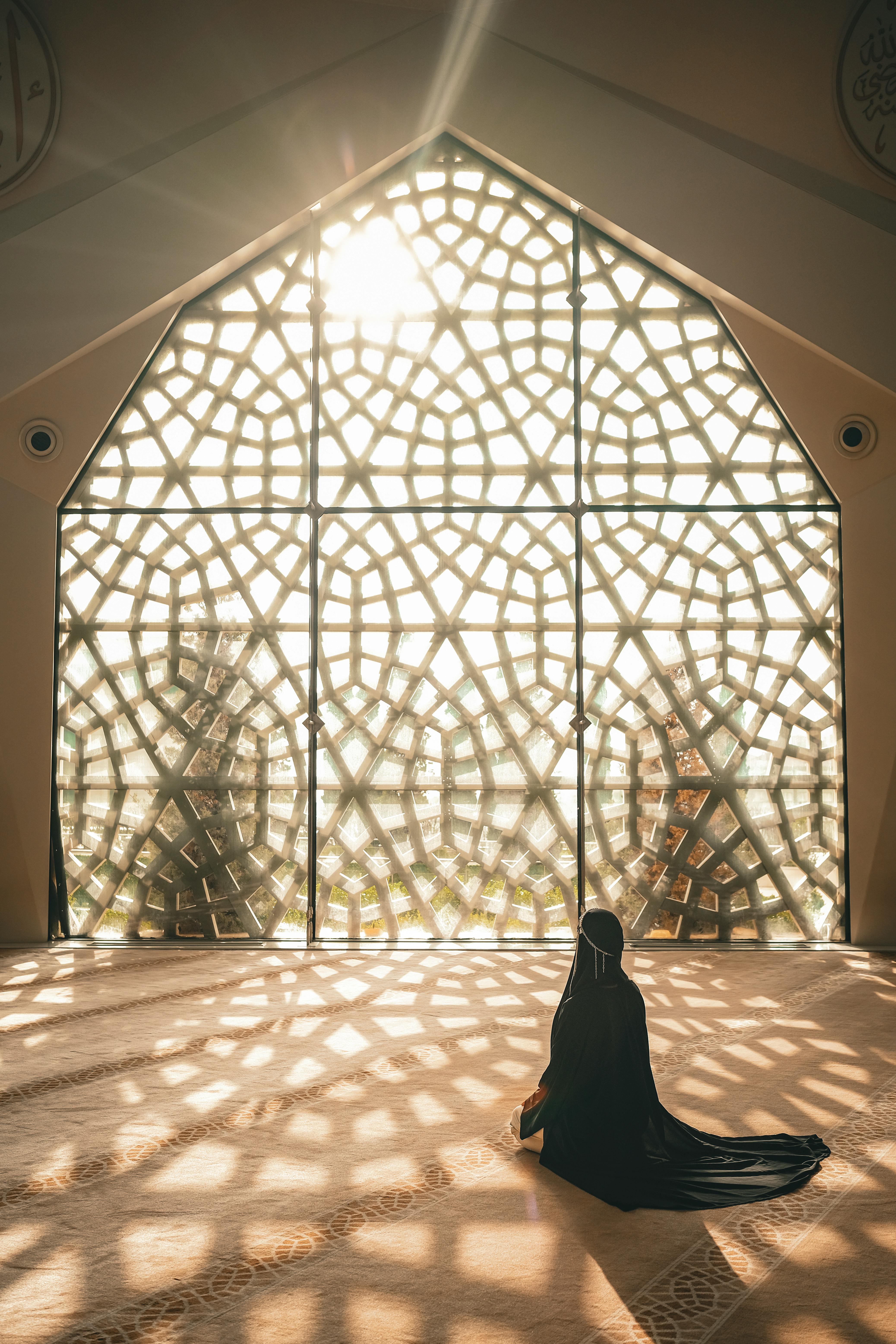 A Person Kneeling in Front of a Window · Free Stock Photo
