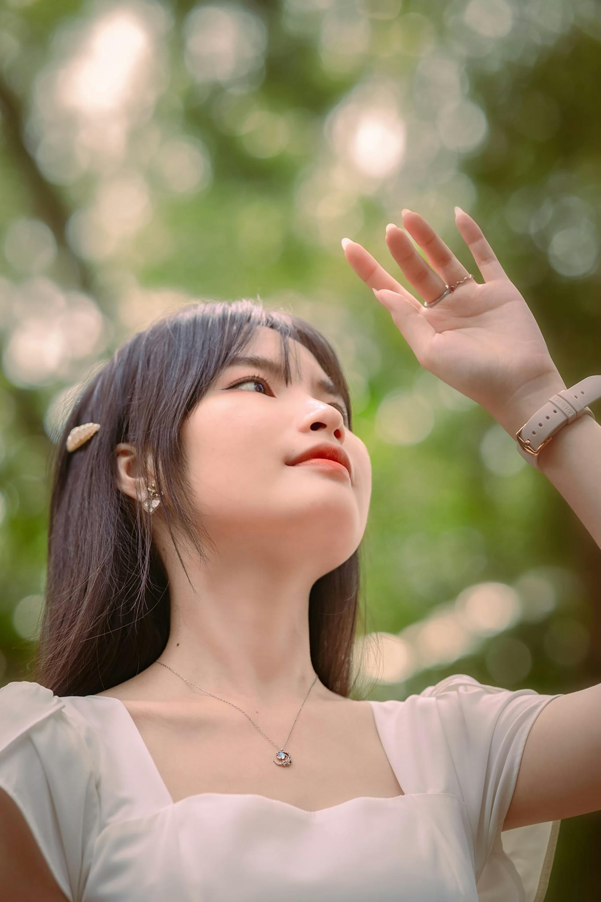 Young Woman Looking at the Back of Her Hand · Free Stock Photo