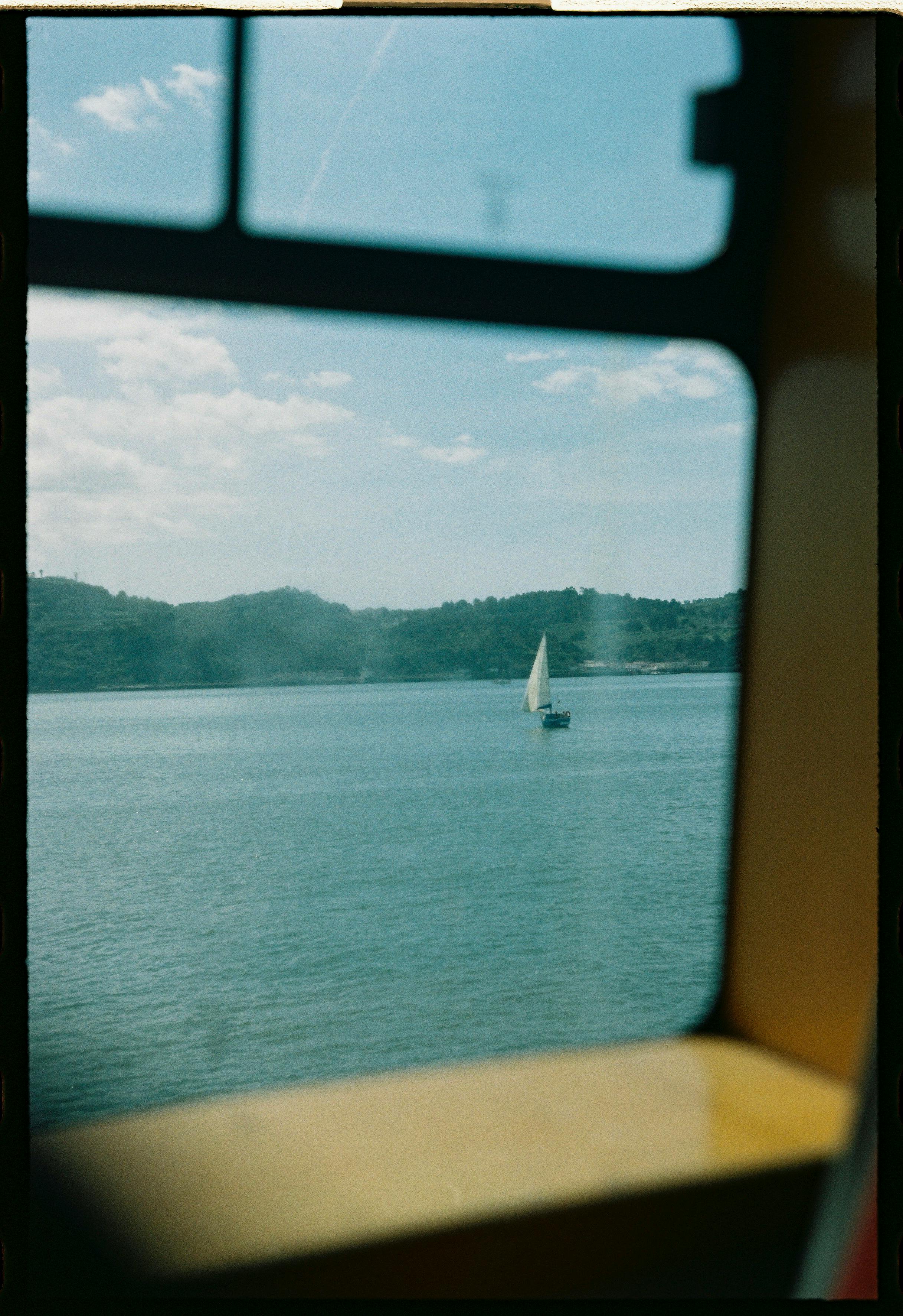 A view of a sailboat from a window · Free Stock Photo