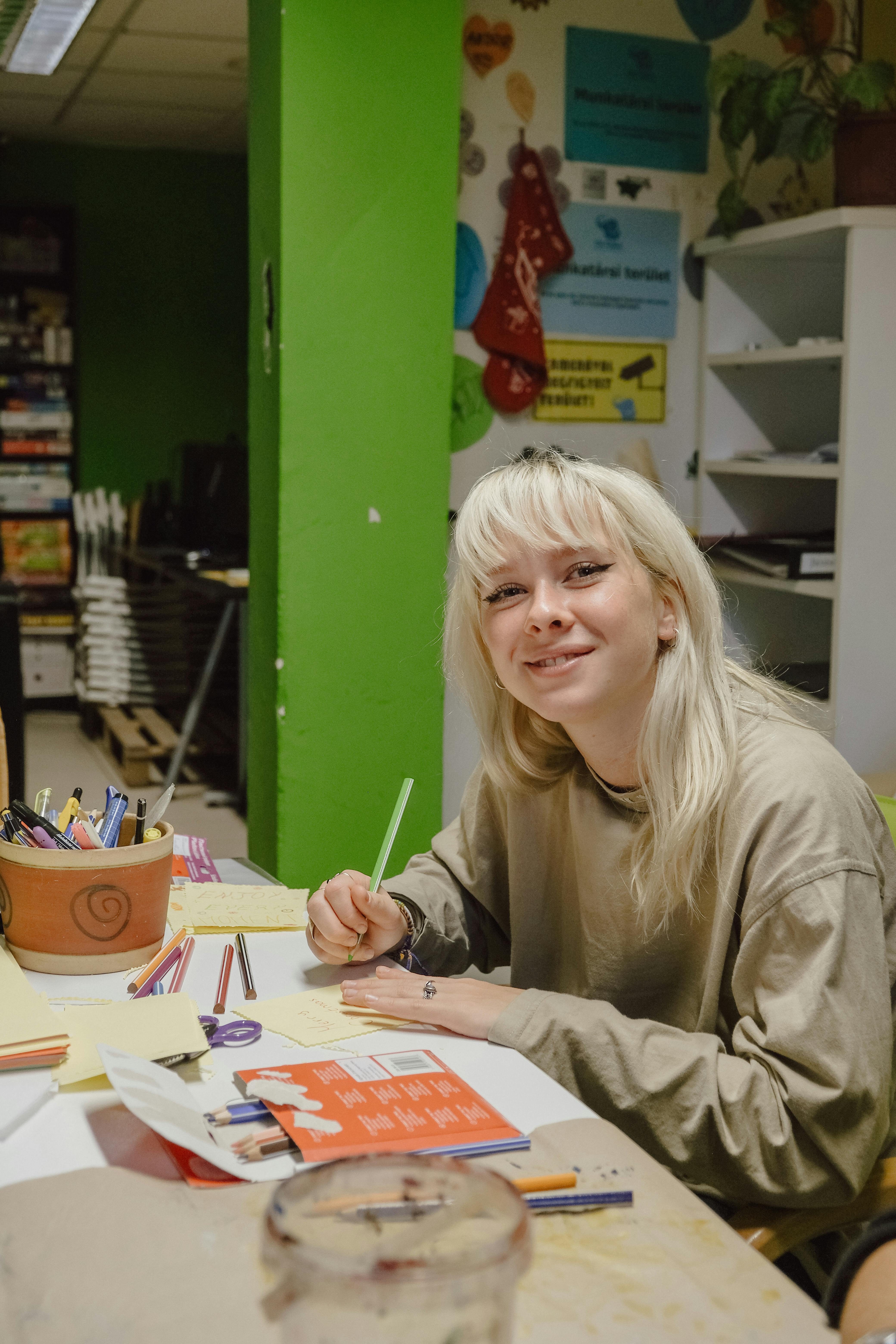 Woman Drawing by the Desk · Free Stock Photo