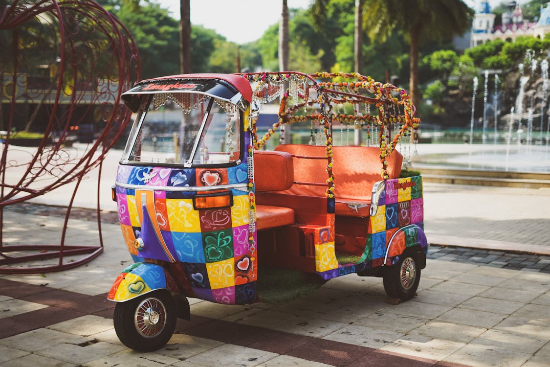 A colorful tuk tuk parked in front of a fountain · Free Stock Photo A colorful tuk tuk parked in front of a fountain · Free Stock Photo