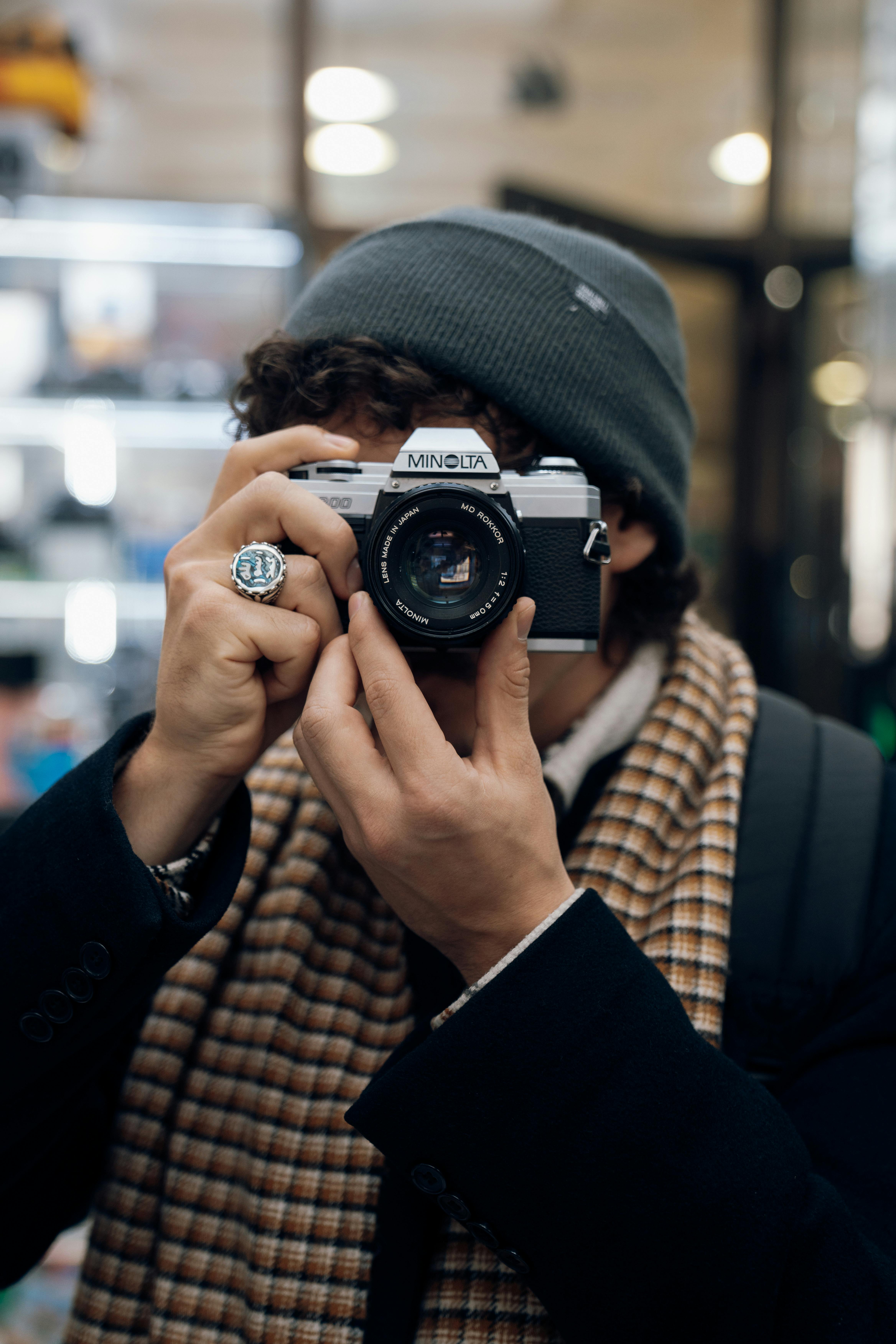 Person Using Camera Photo on Brown Surface · Free Stock Photo