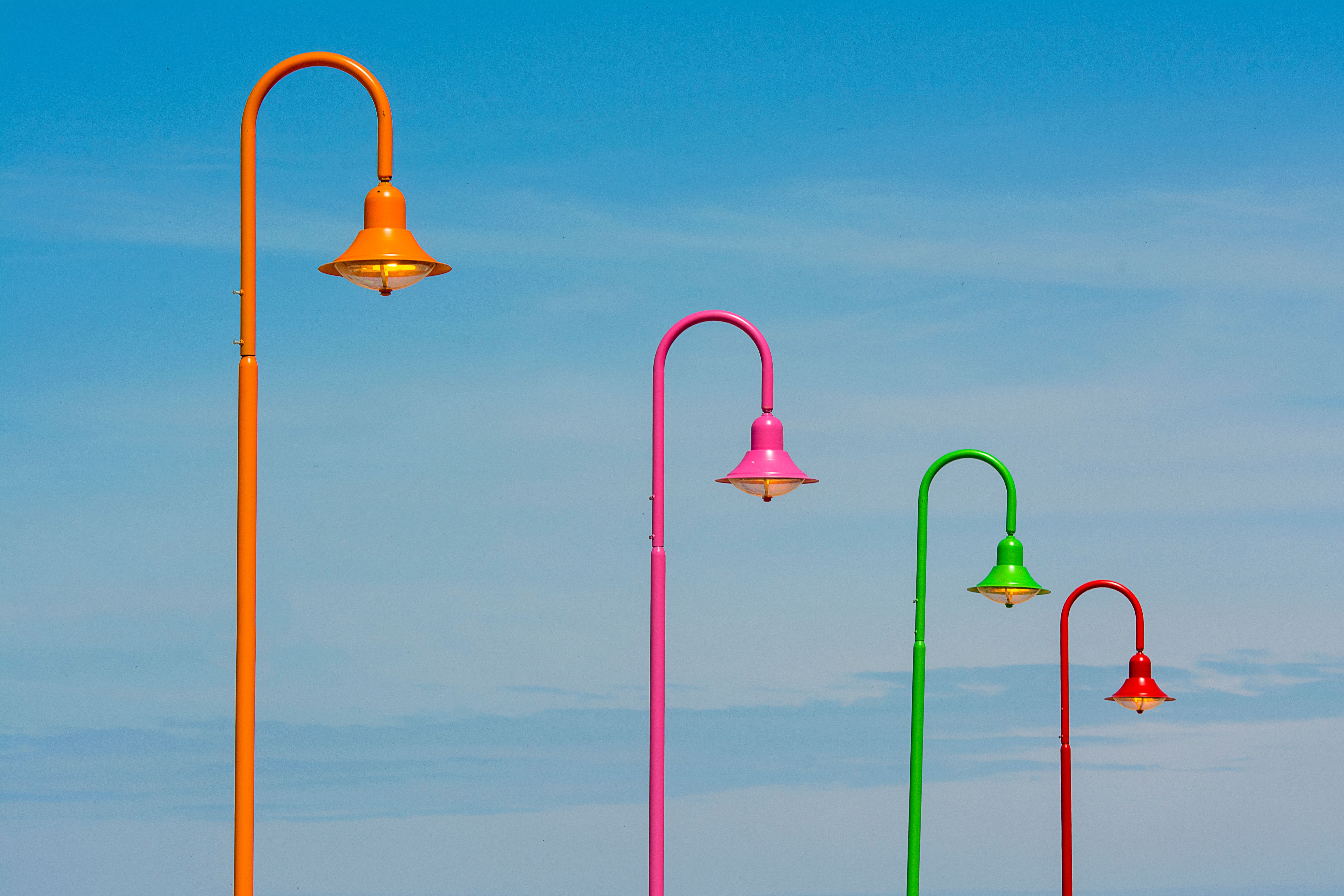 Colorful Streetlamps Against Sky · Free Stock Photo