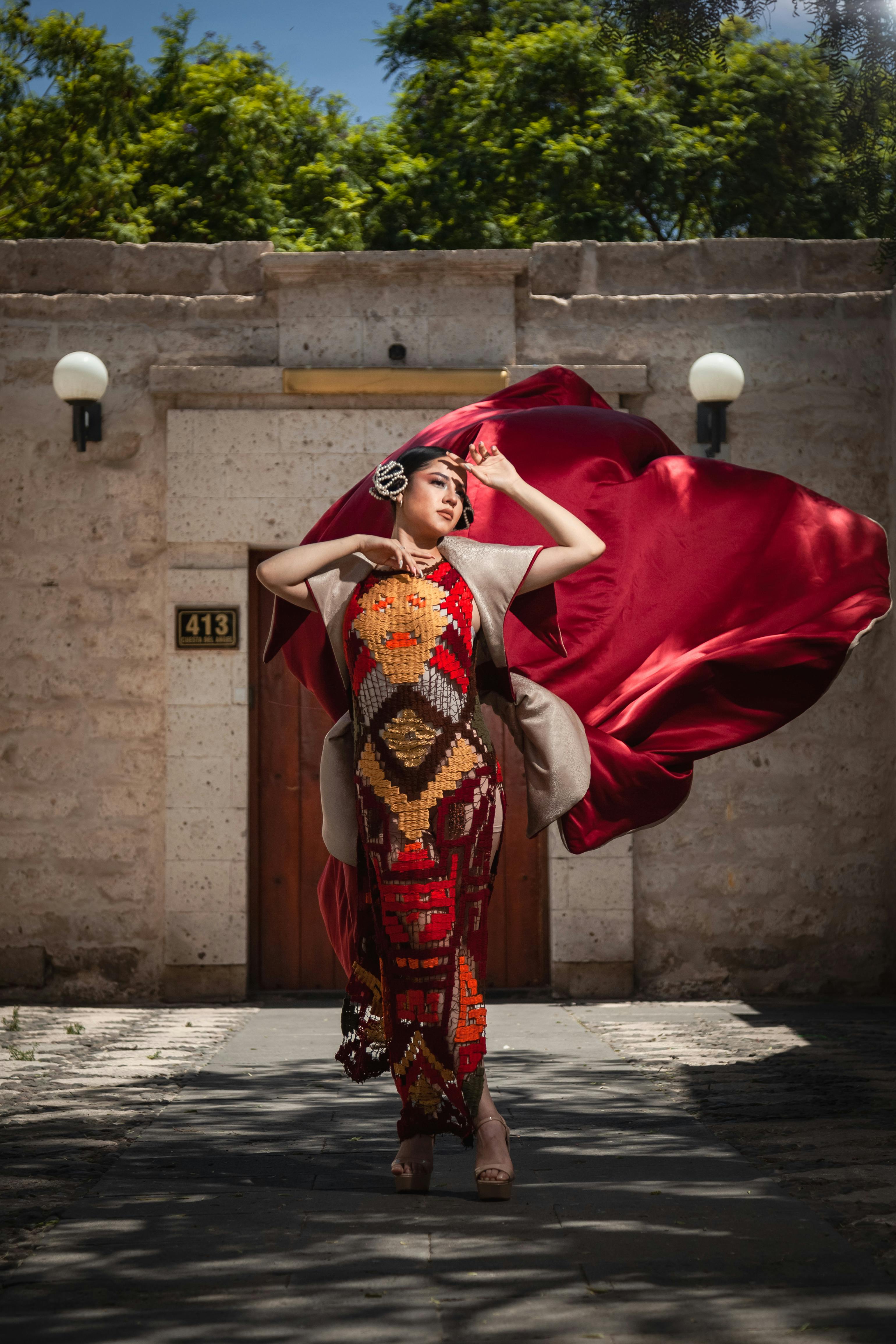 Model in a Traditionally Embroidered Dress and a Scarlet Robe Flowing ...