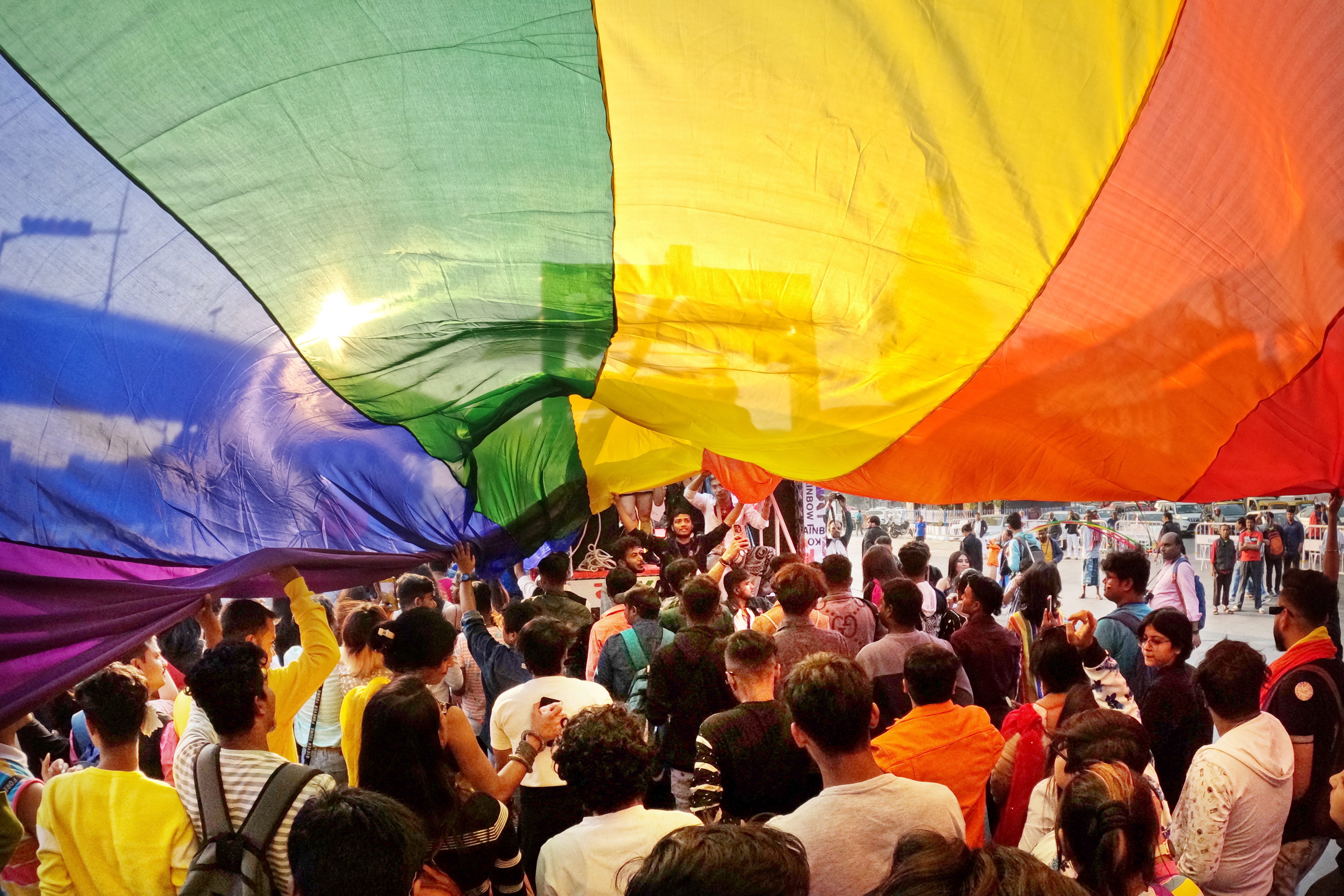 LGBTQ Pride Parade Crowd with Rainbow Flag · Free Stock Photo