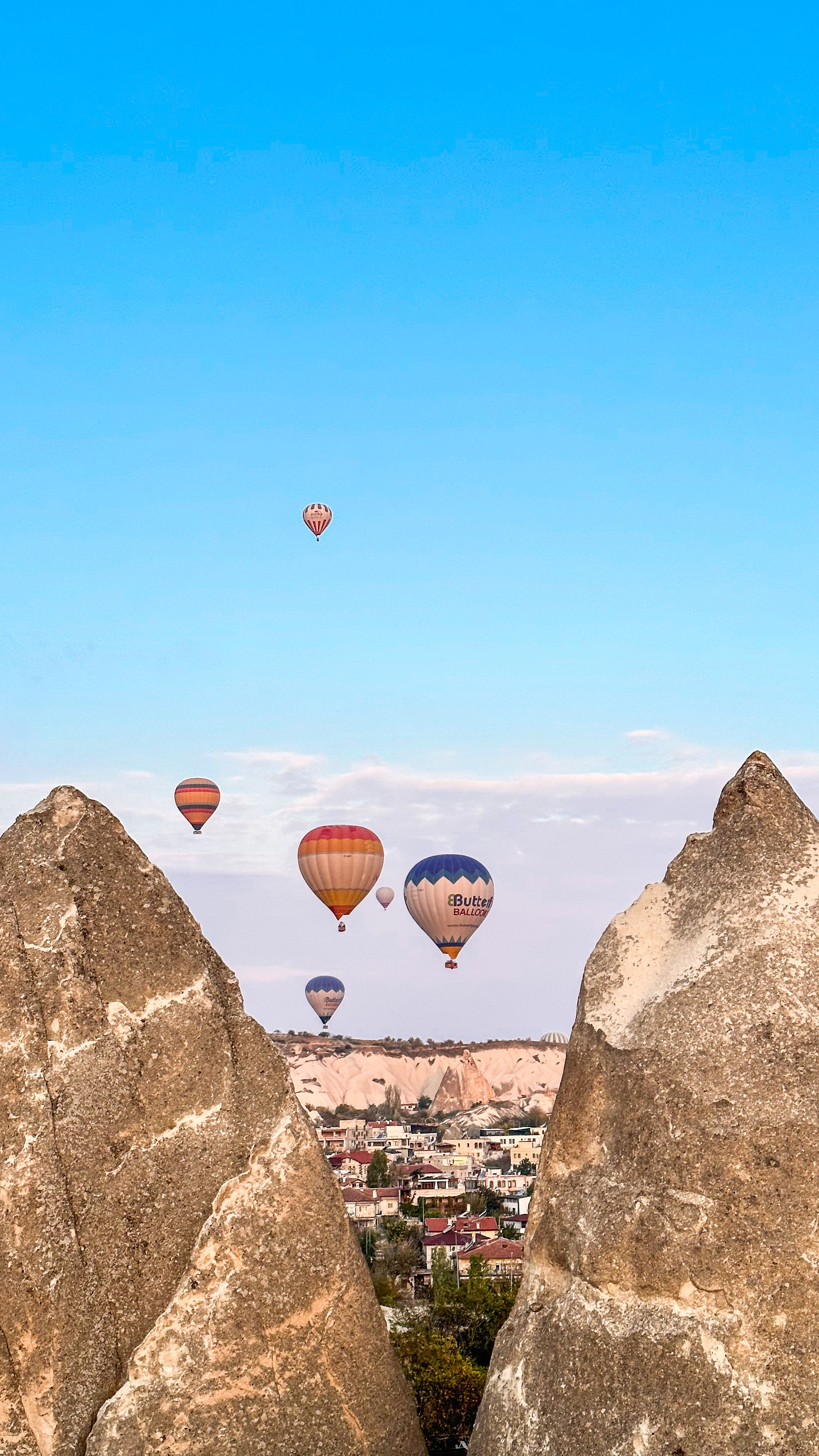 Hot Air Balloons Seen between Rocks · Free Stock Photo