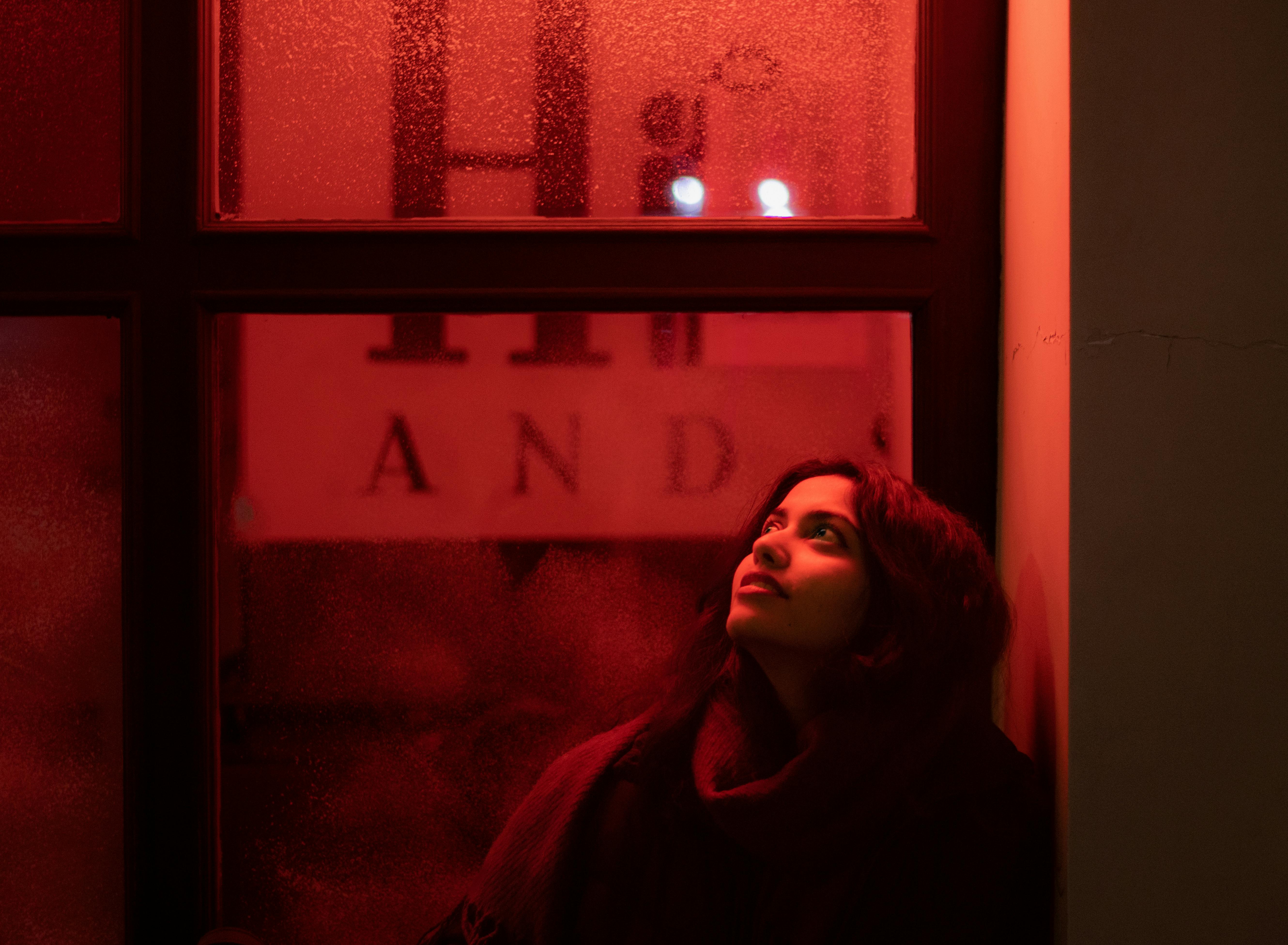 Young Brunette in Red Light at Night · Free Stock Photo